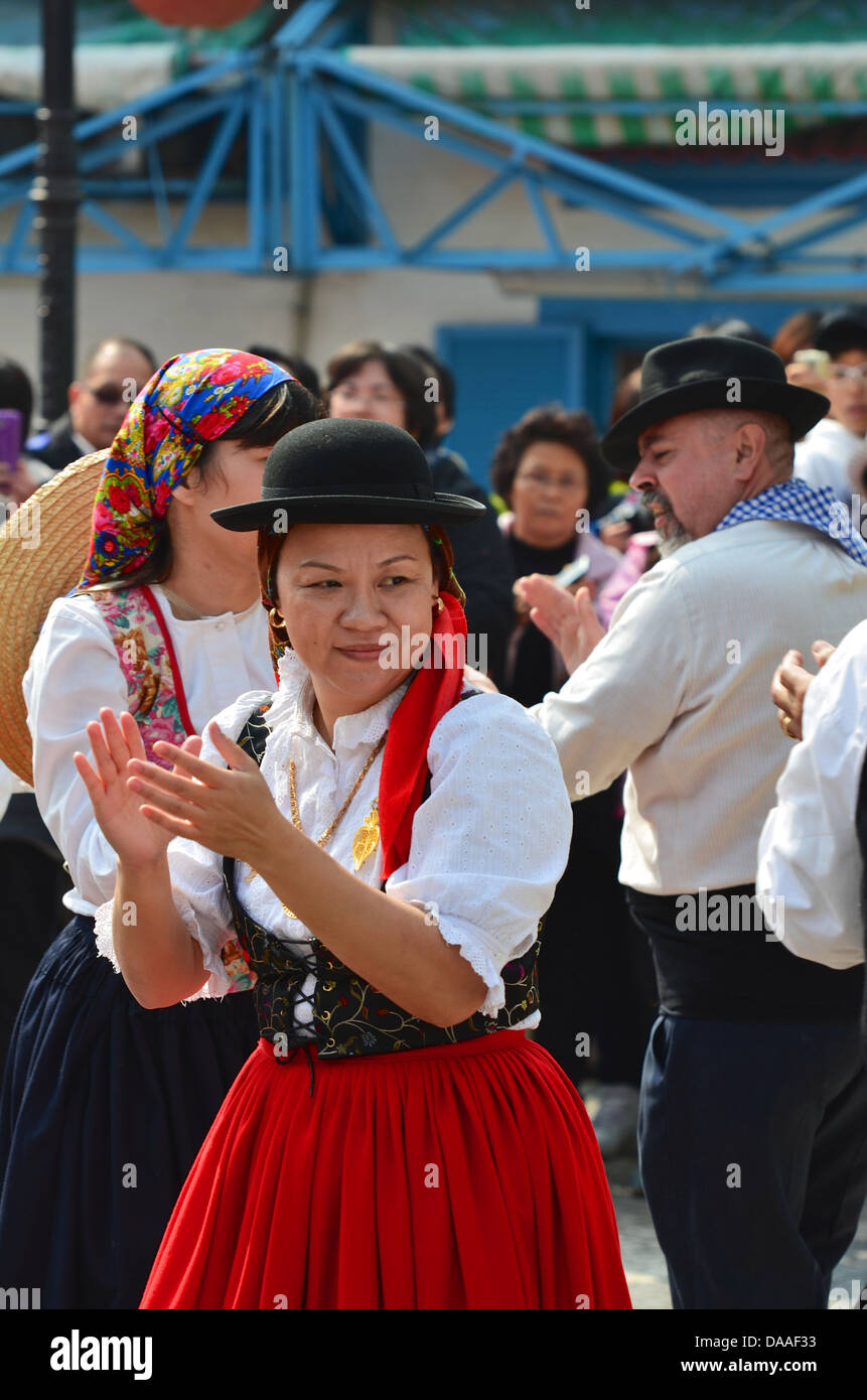 Dancers in traditional Portuguese dress take part in folk dancing at ...