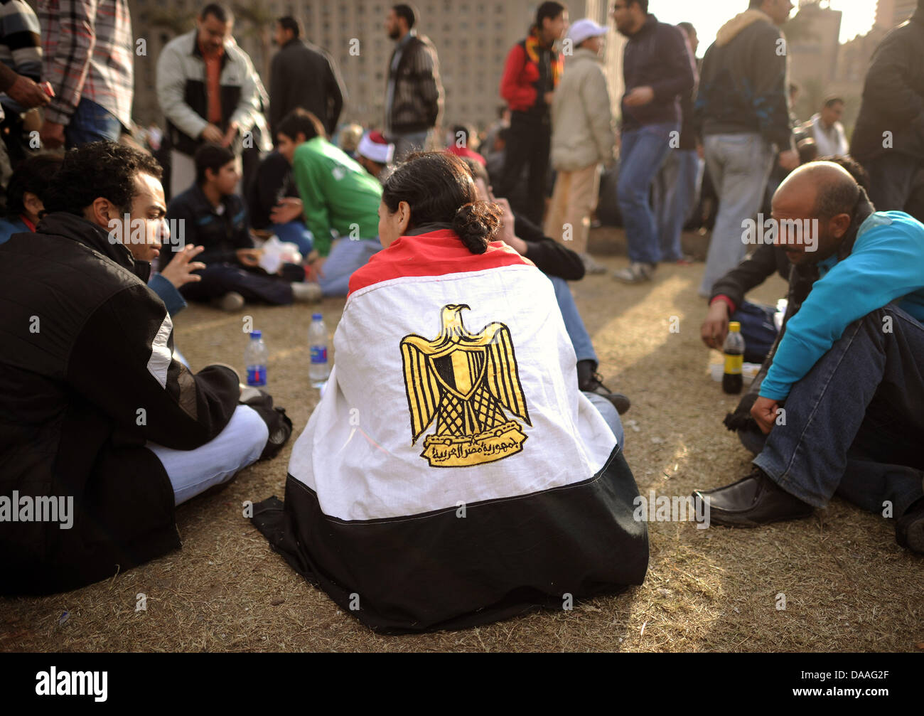 A demonstrator has wound the Egyptian flag around his shoulders at the ...