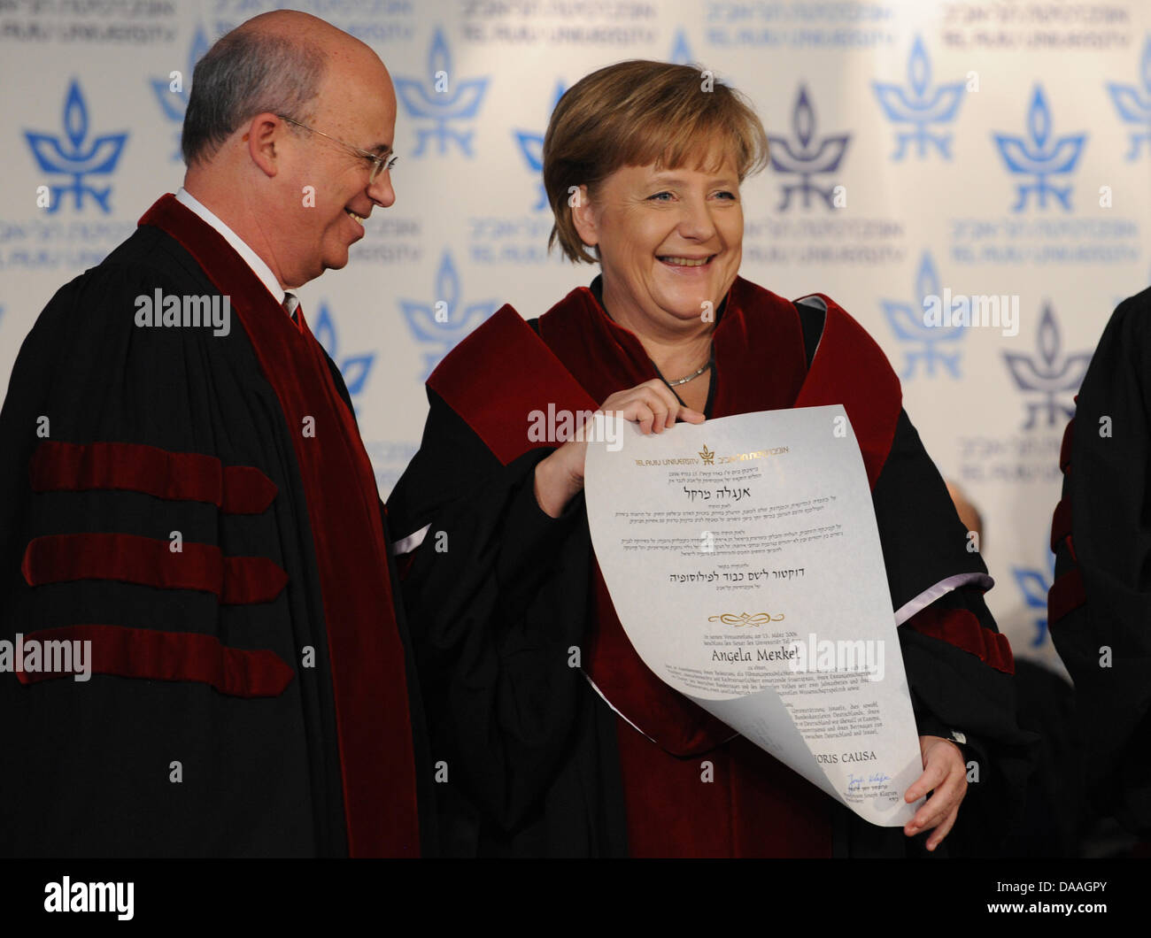 German Chancellor Angela Merkel (R) is awarded with an honourary ...