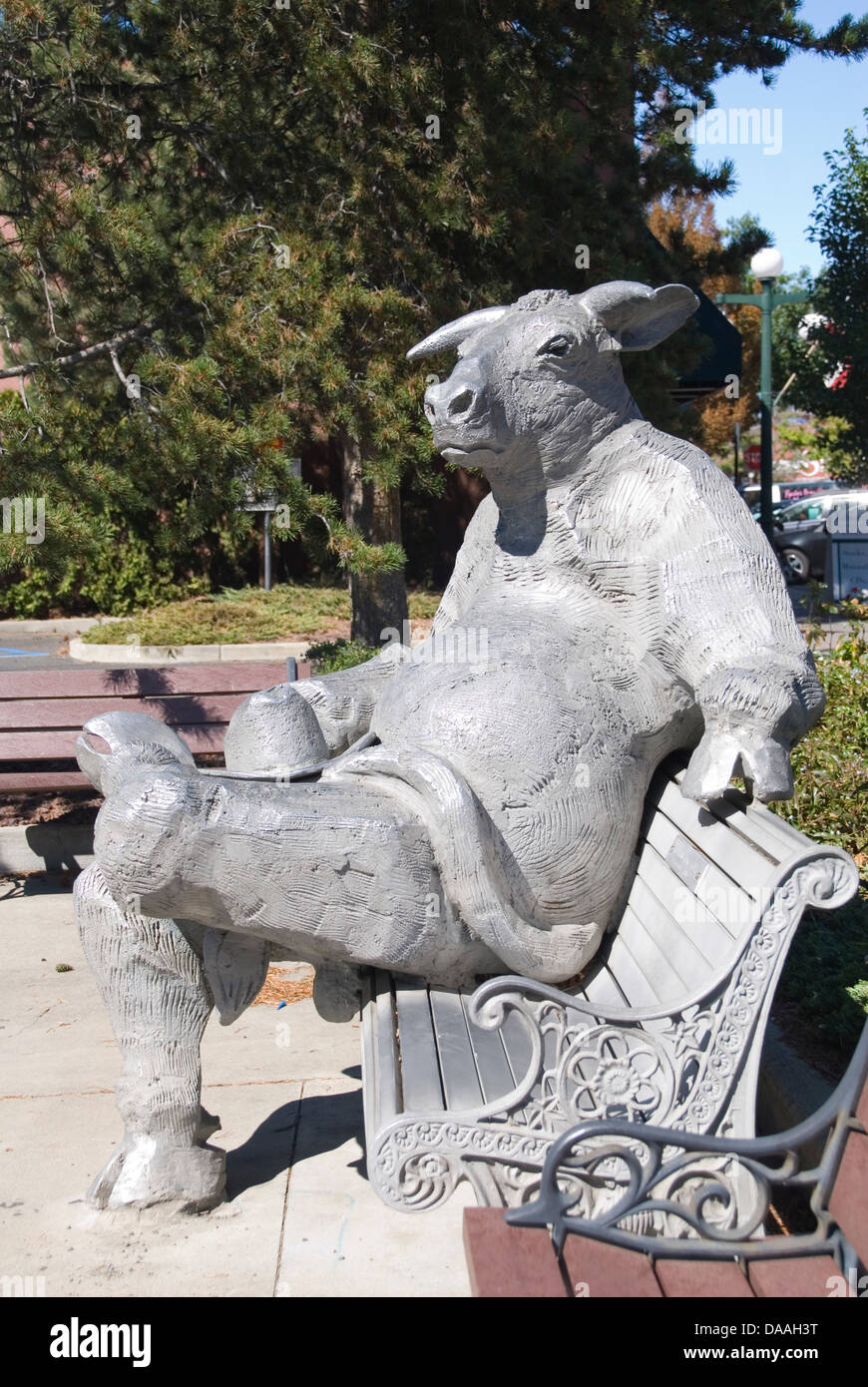 The Ellensburg Bull, a cement statue sitting on a bench in downtown ...