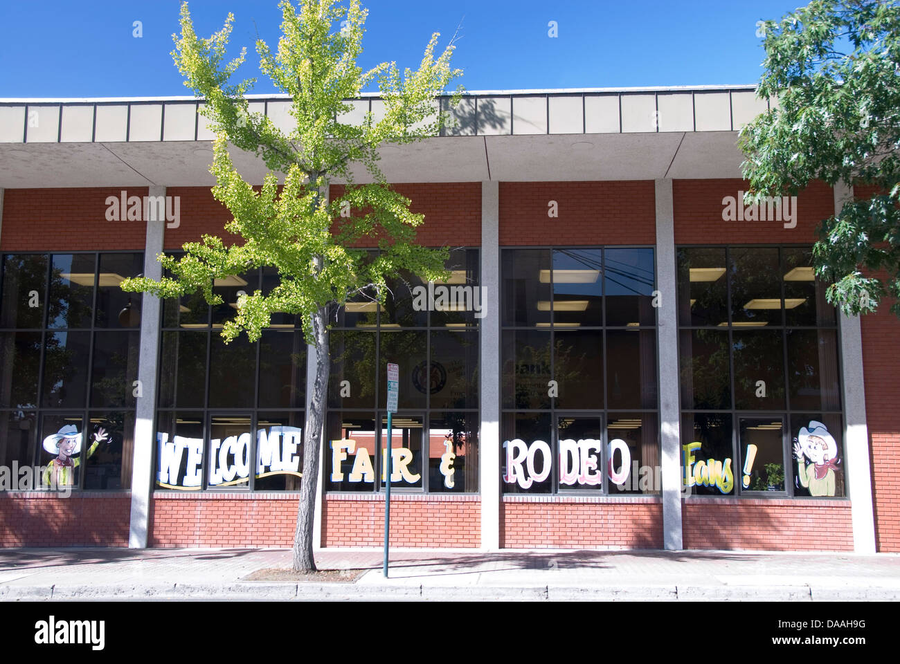 Welcome Fair & Rodeo Fans sign written on a shopfront in downtown ...