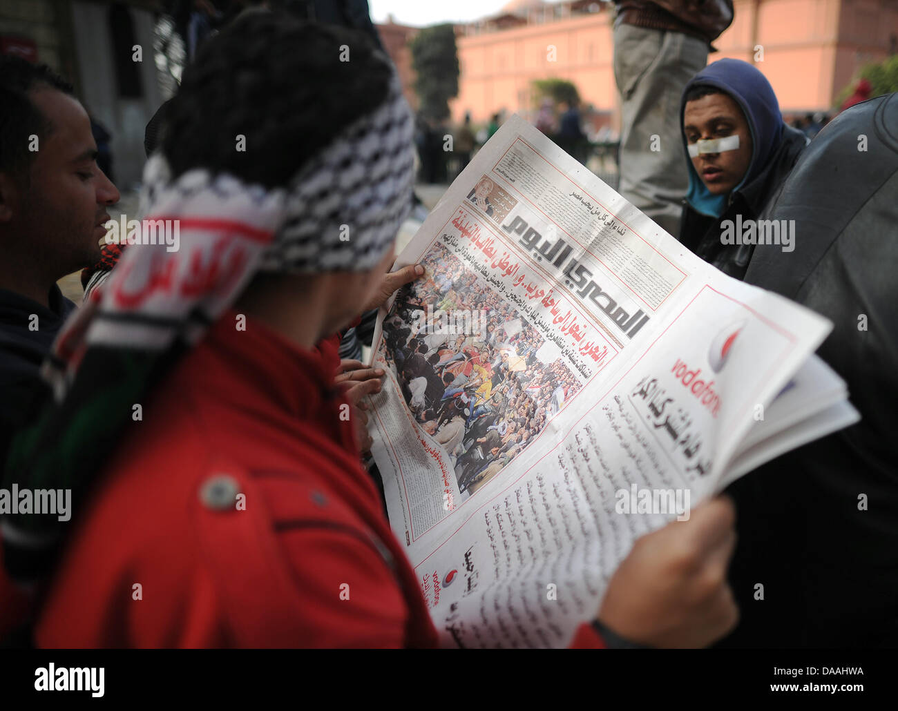 Demonstrators read a newspaper at the Tahrir Square in Cairo, Egypt, 03 ...