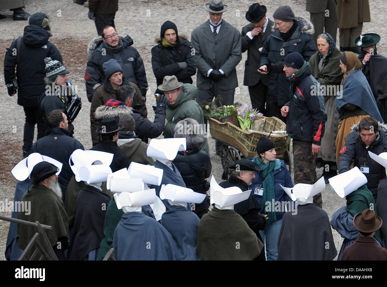 British director Guy Ritchie (C, grey felt hat) talks to people on set ...