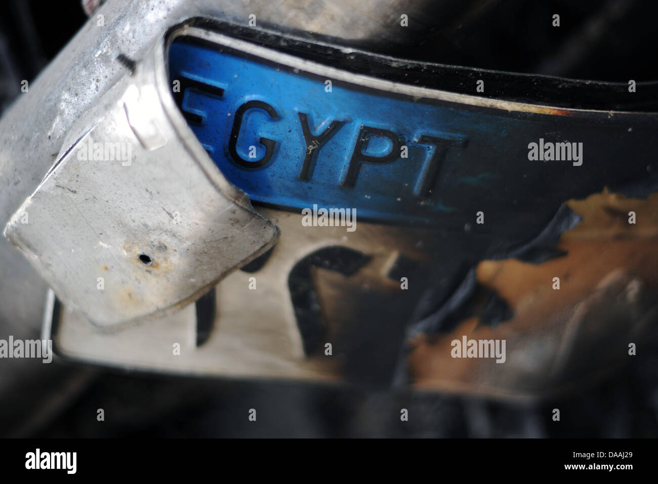 A damaged licence plate with the lettering 'Egypt' is still attached to ...