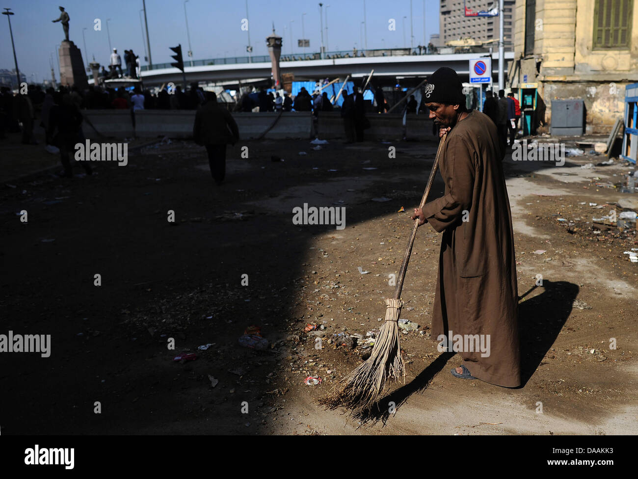 People start cleaning streets close to Tahrir square, in Cairo, Egypt ...