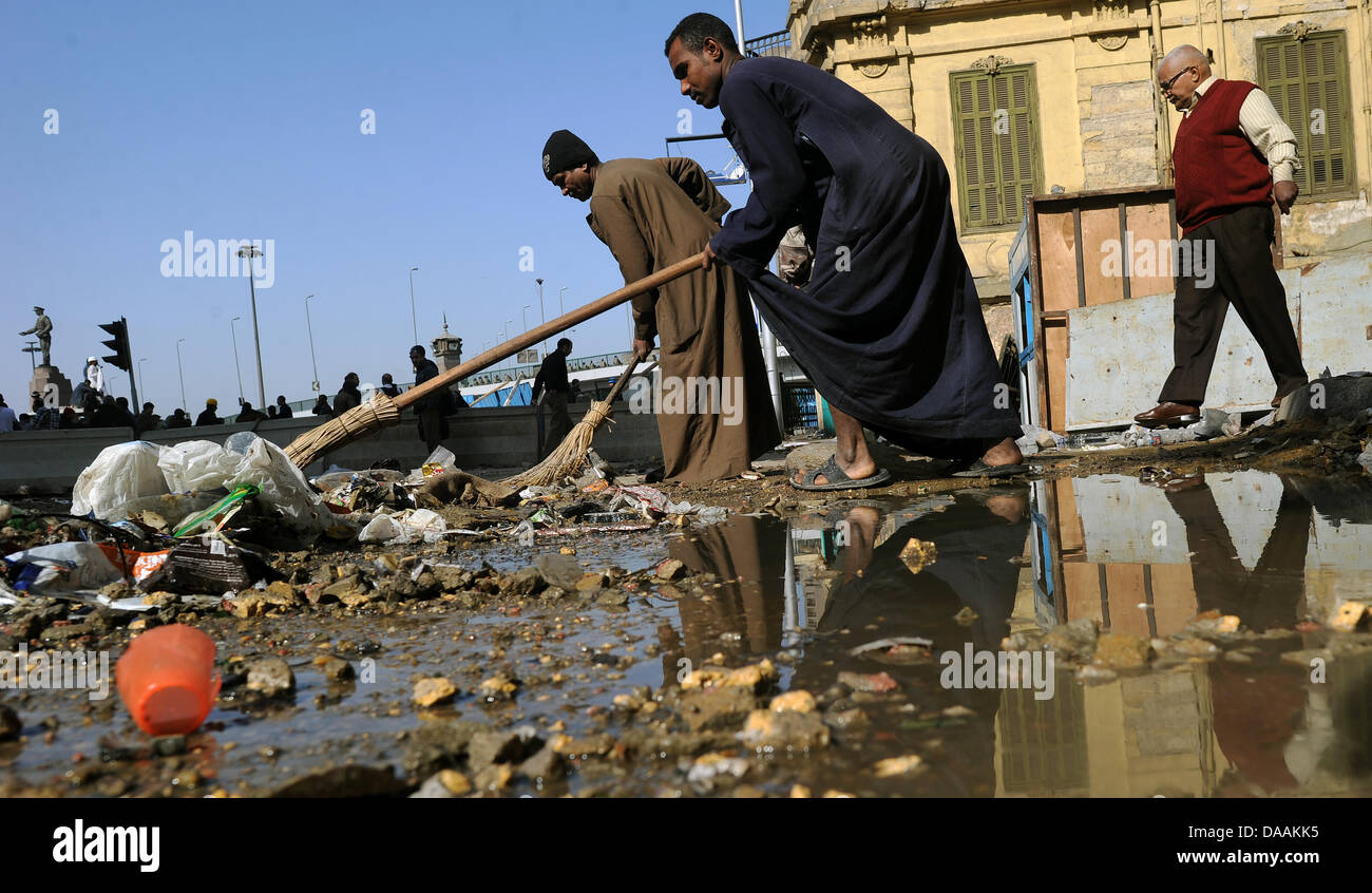 People start cleaning streets close to Tahrir square, in Cairo, Egypt ...