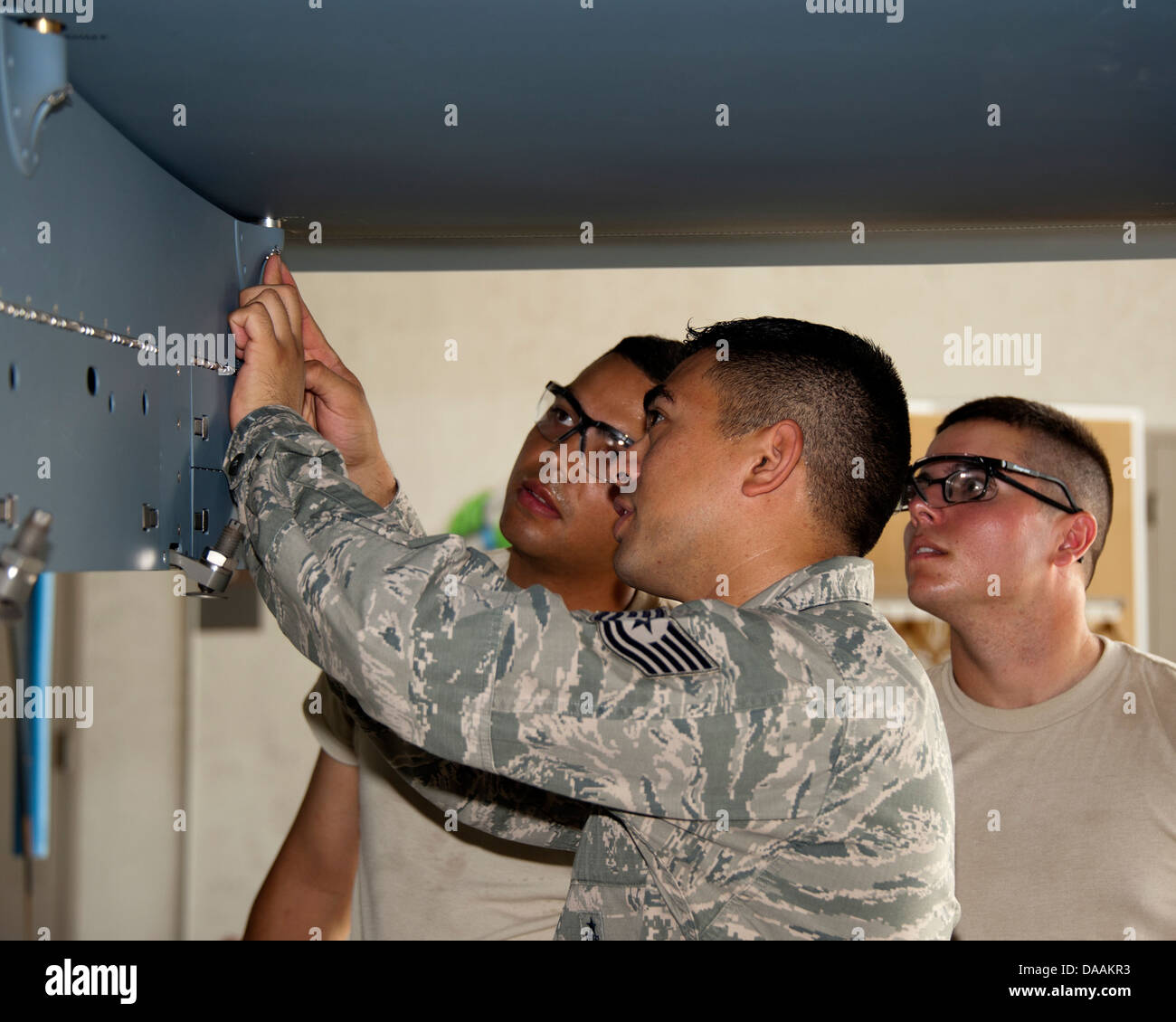 U.S. Air Force Airman 1st Class Aric Abing and Airman 1st Class Christopher Williamson listen to ...