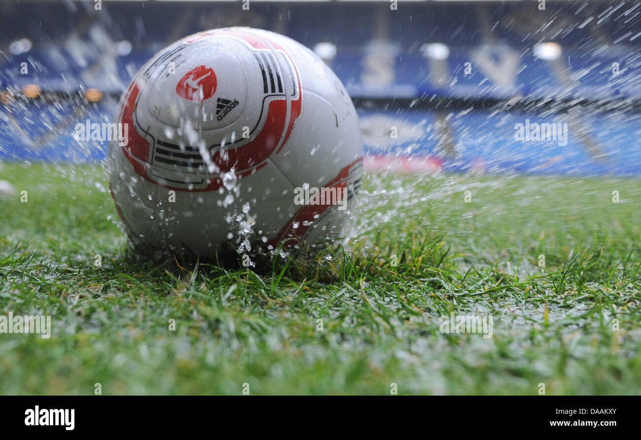 A soccer ball makes a splash as it hits the soaking wet pitch at Imtech ...