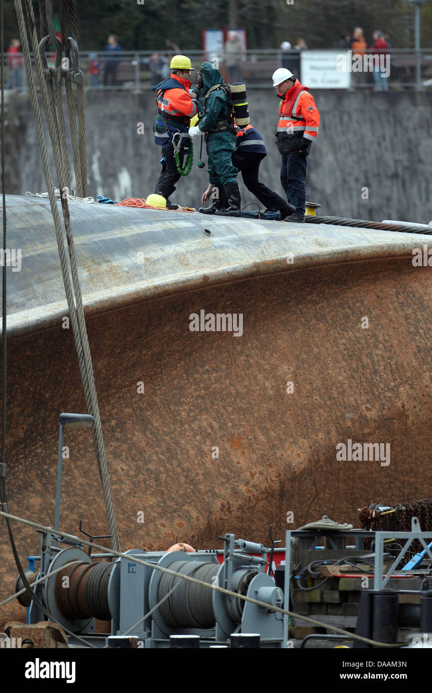 Specialists pump sulphuric acid from a capsized tanker onto another ...