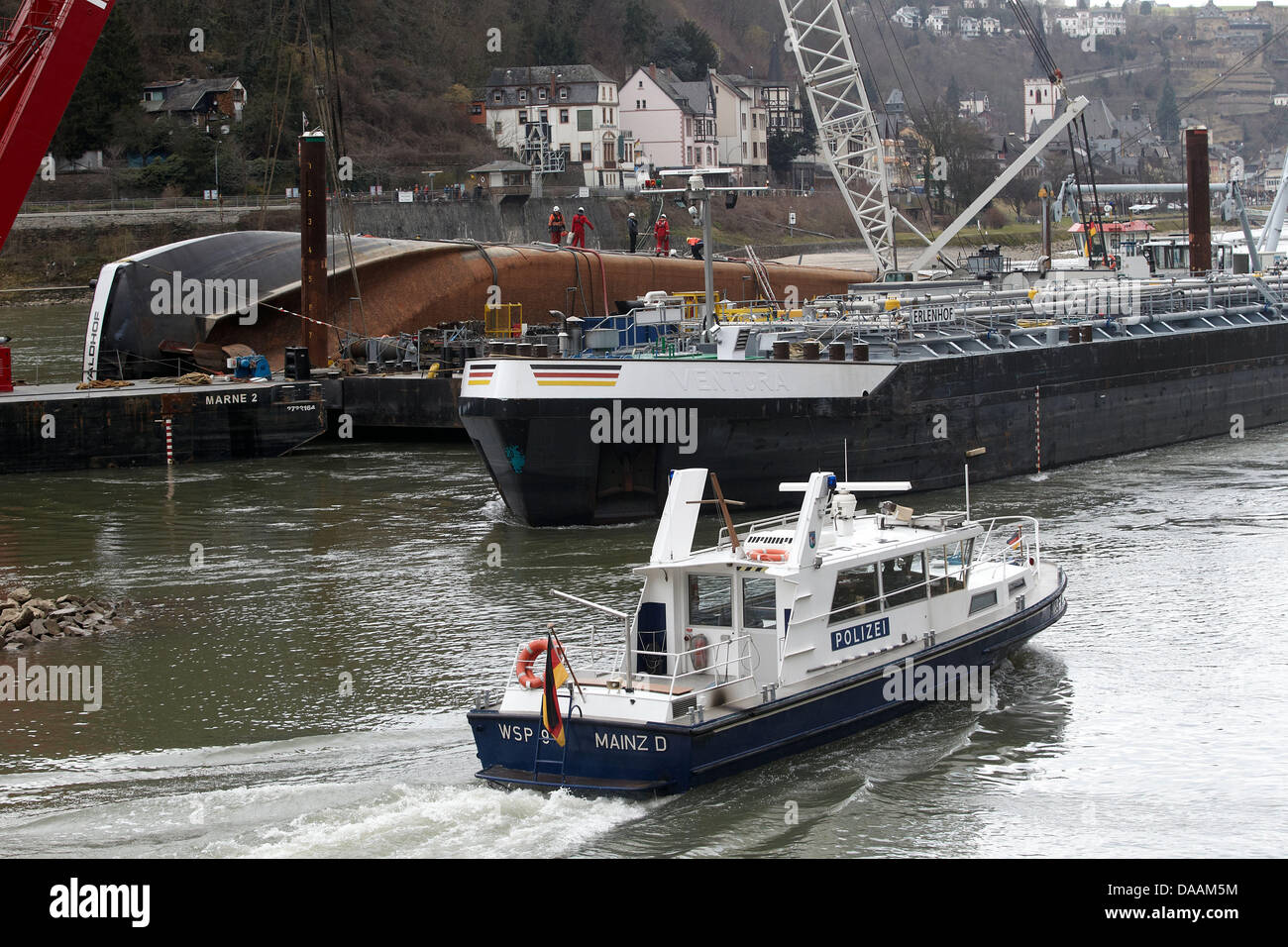 A water guard boat passes a capsized tanker whose cargo of sulphuric ...