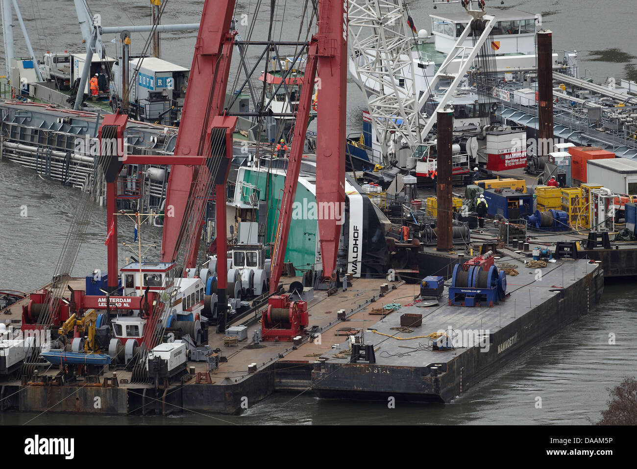 A crane has been brought into position nextz to a capsized tanker whose ...