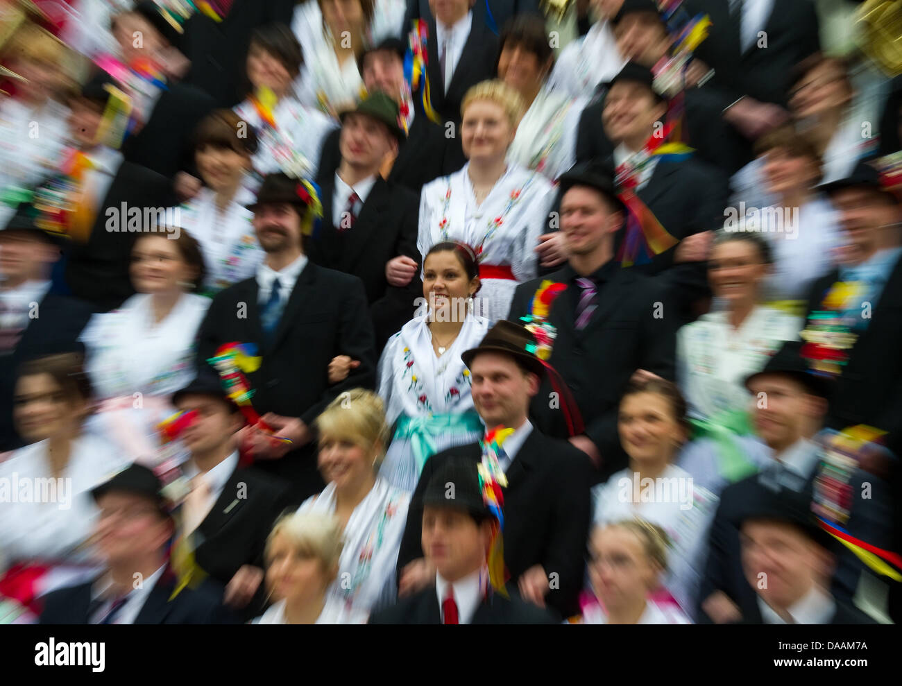 A crowd of men and women dressed in traditional Sorbian costumes ...