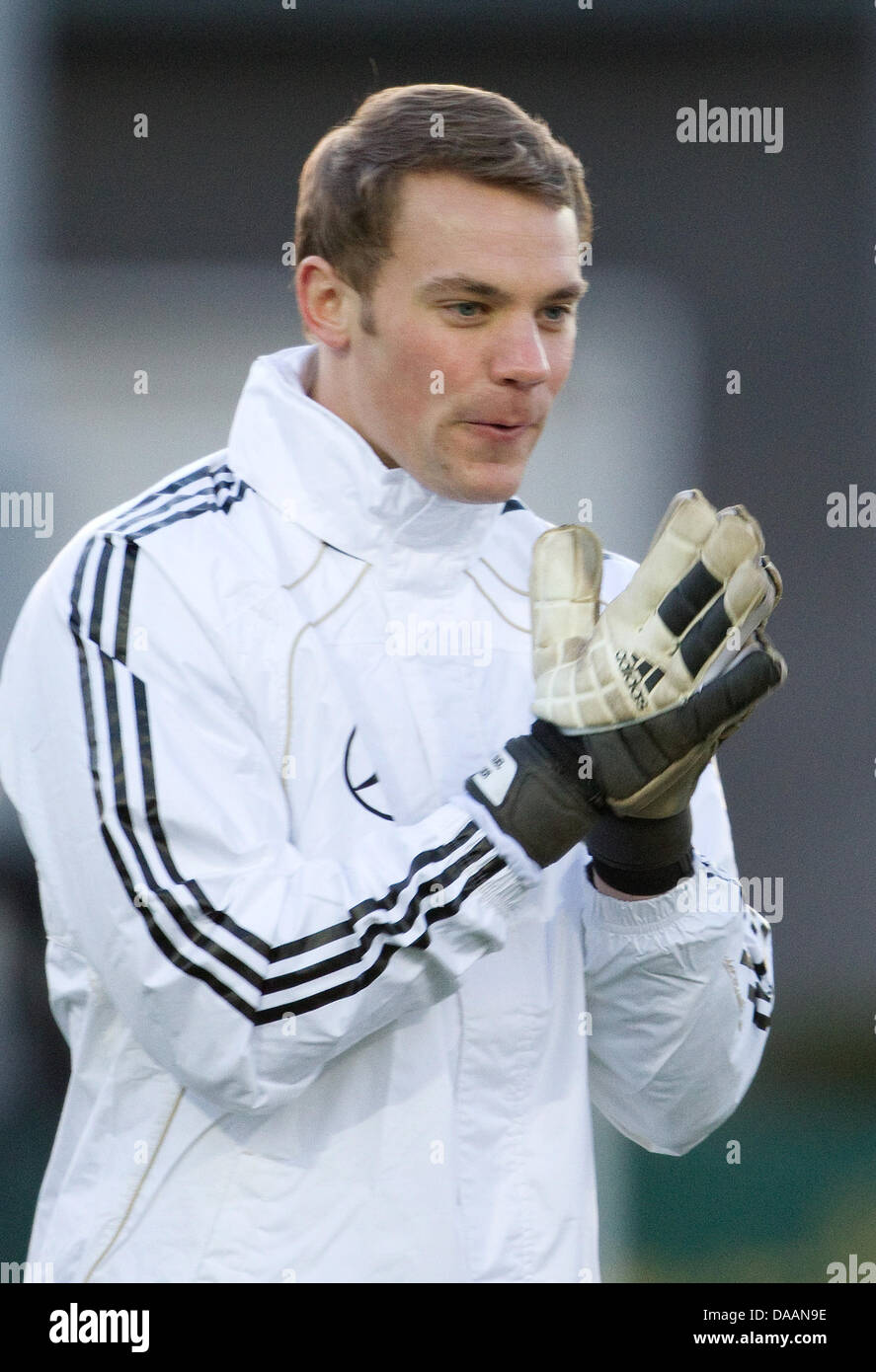 German national team keeper Manuel Neuer spits in his hands during a ...