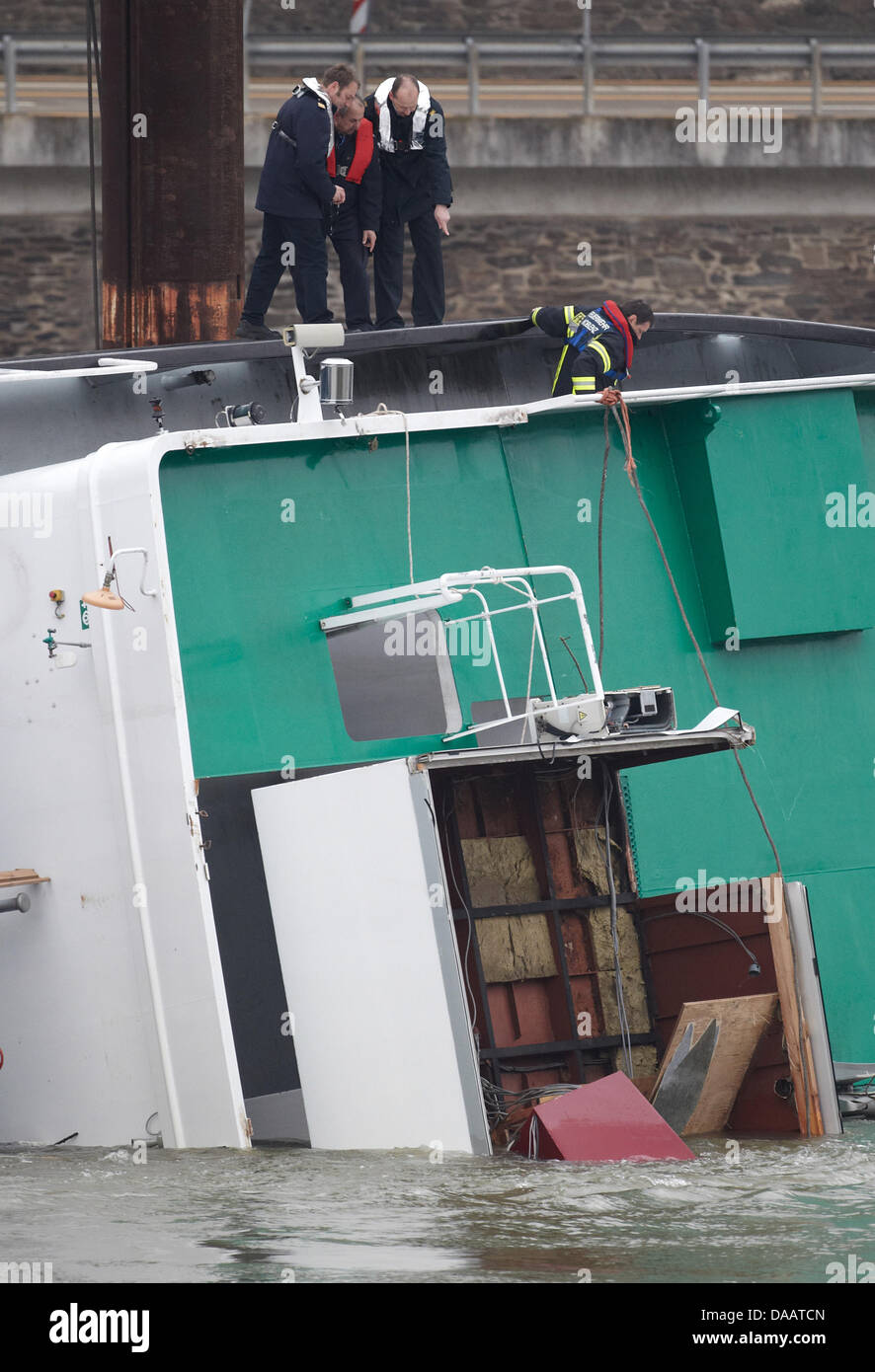 Rescue forces inspect the capsized barge carrying acid in St ...