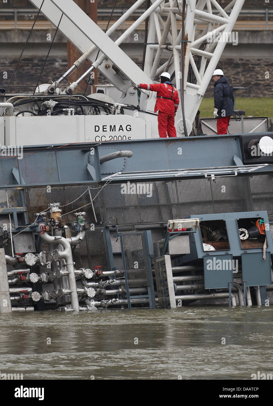Rescue forces inspect the capsized barge carrying acid in St ...