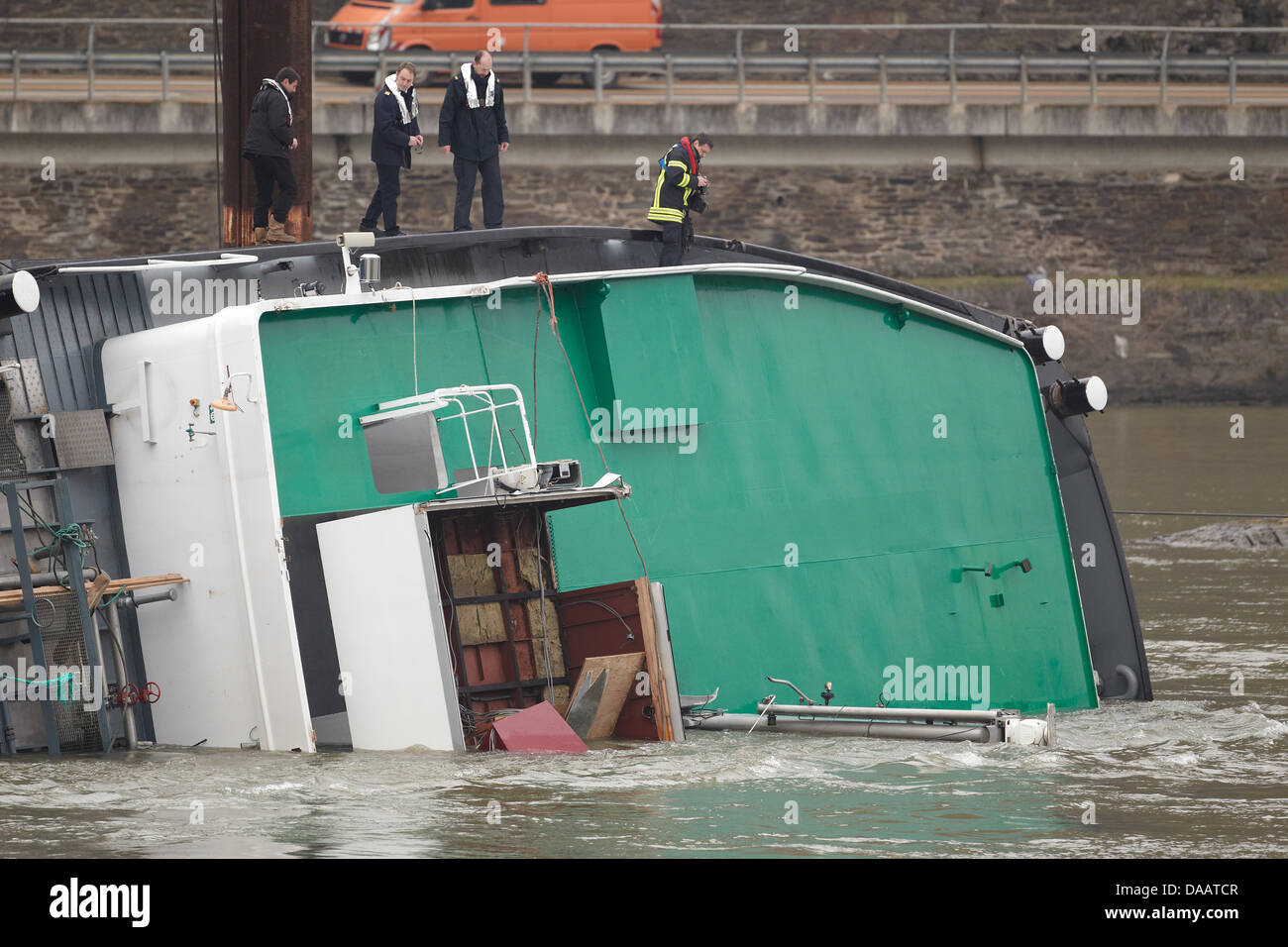 Rescue forces inspect the capsized barge carrying acid in St ...