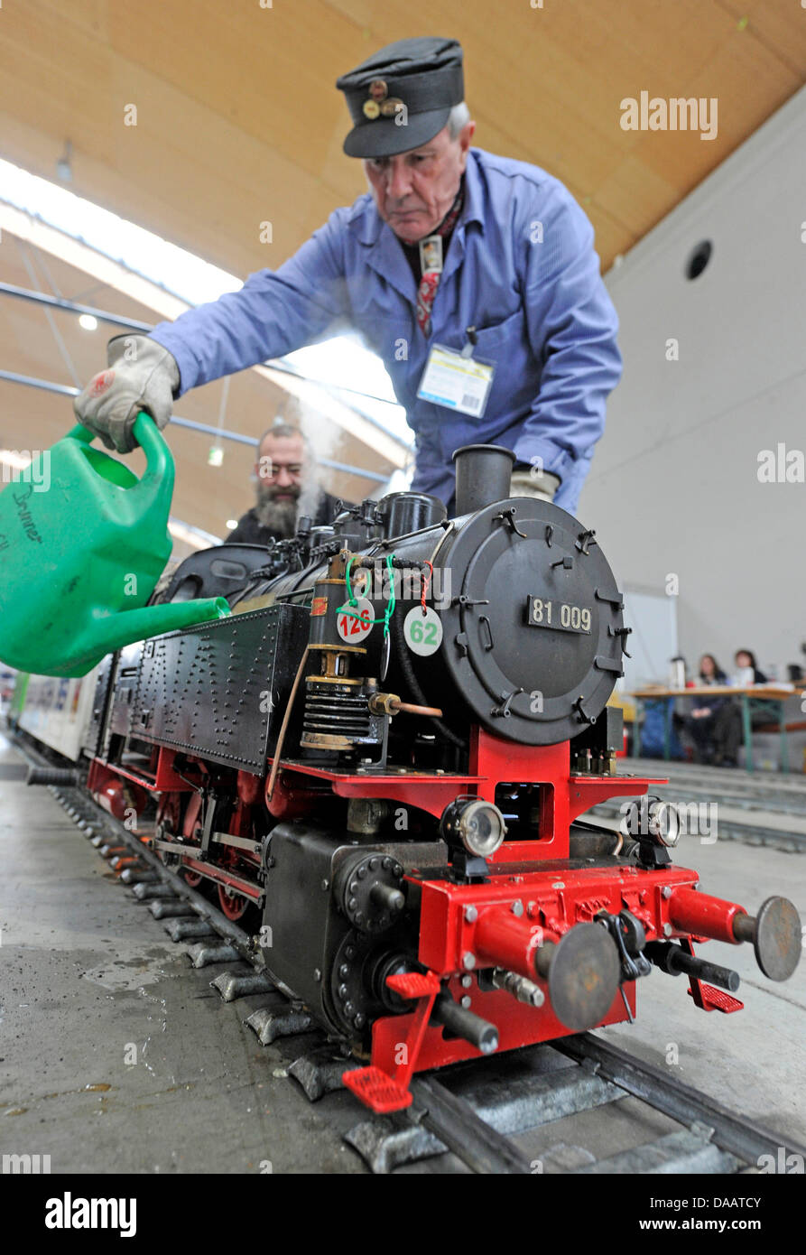 A participant of the 16 Steam engine indoor meeting fills his stean ...