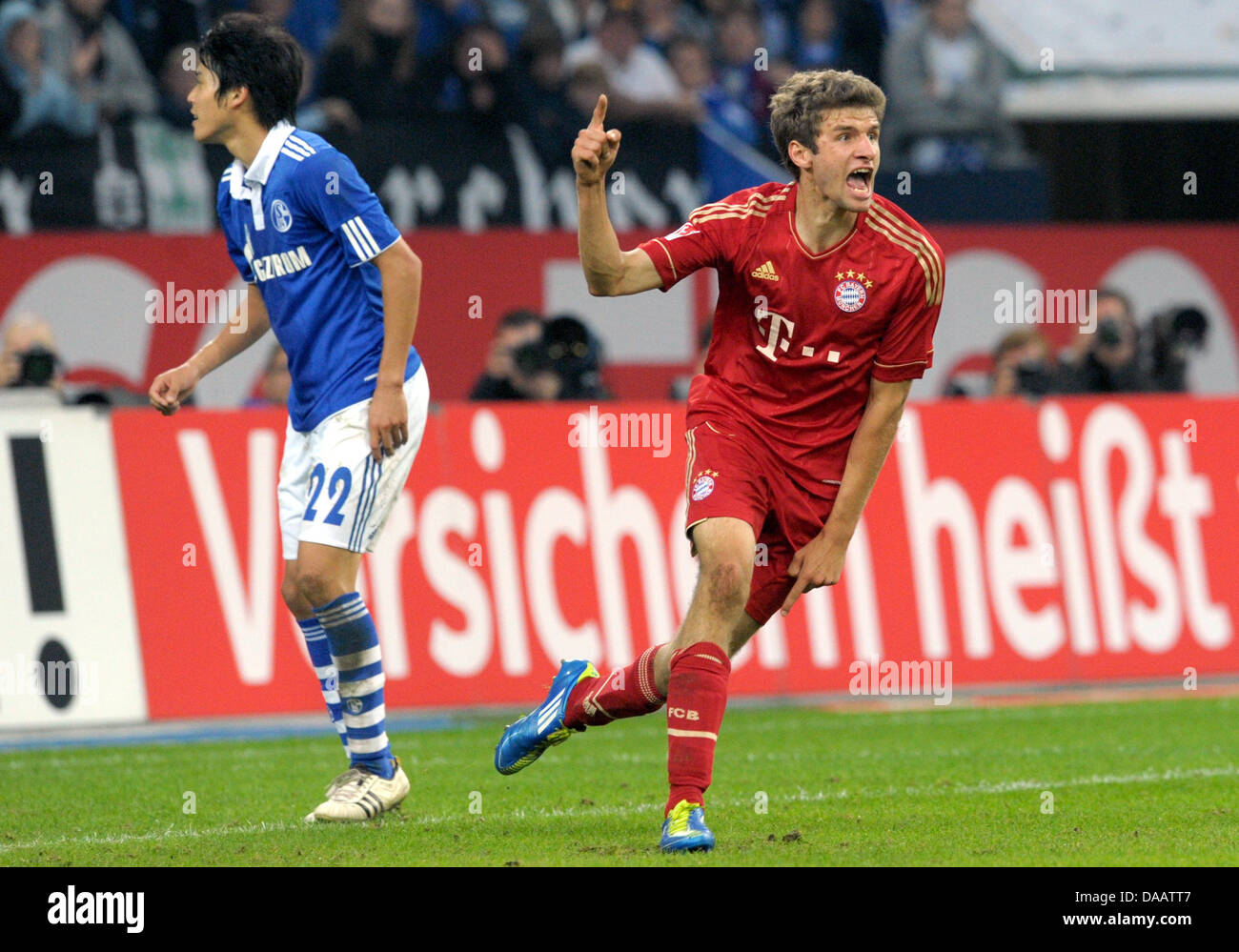 Munich's Thomas Mueller celebrates his 2-0 goal while Schalke's Atsutu ...