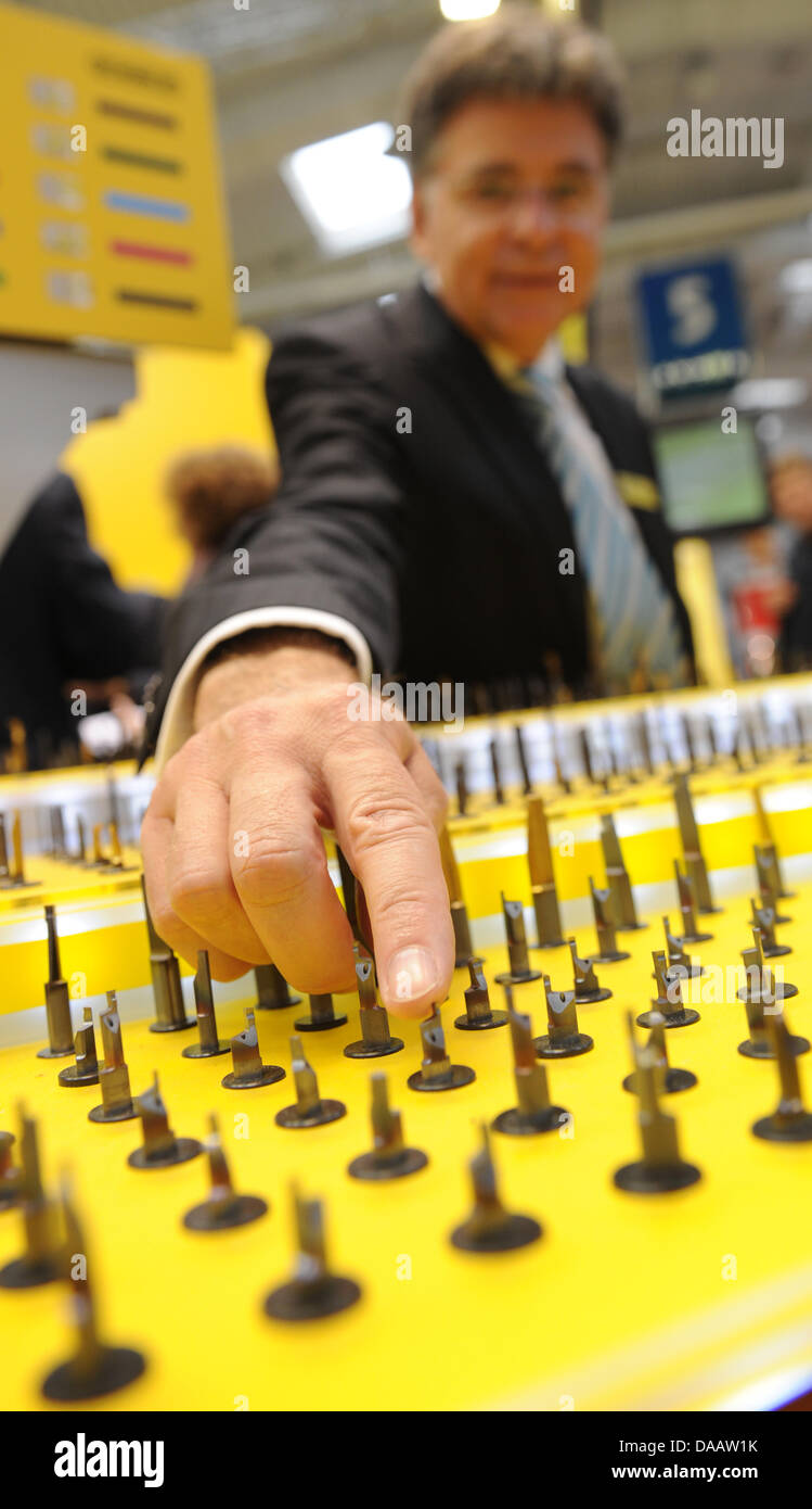 A man points at tools by Horn at the EMO trade fair in Hanover, Germany ...