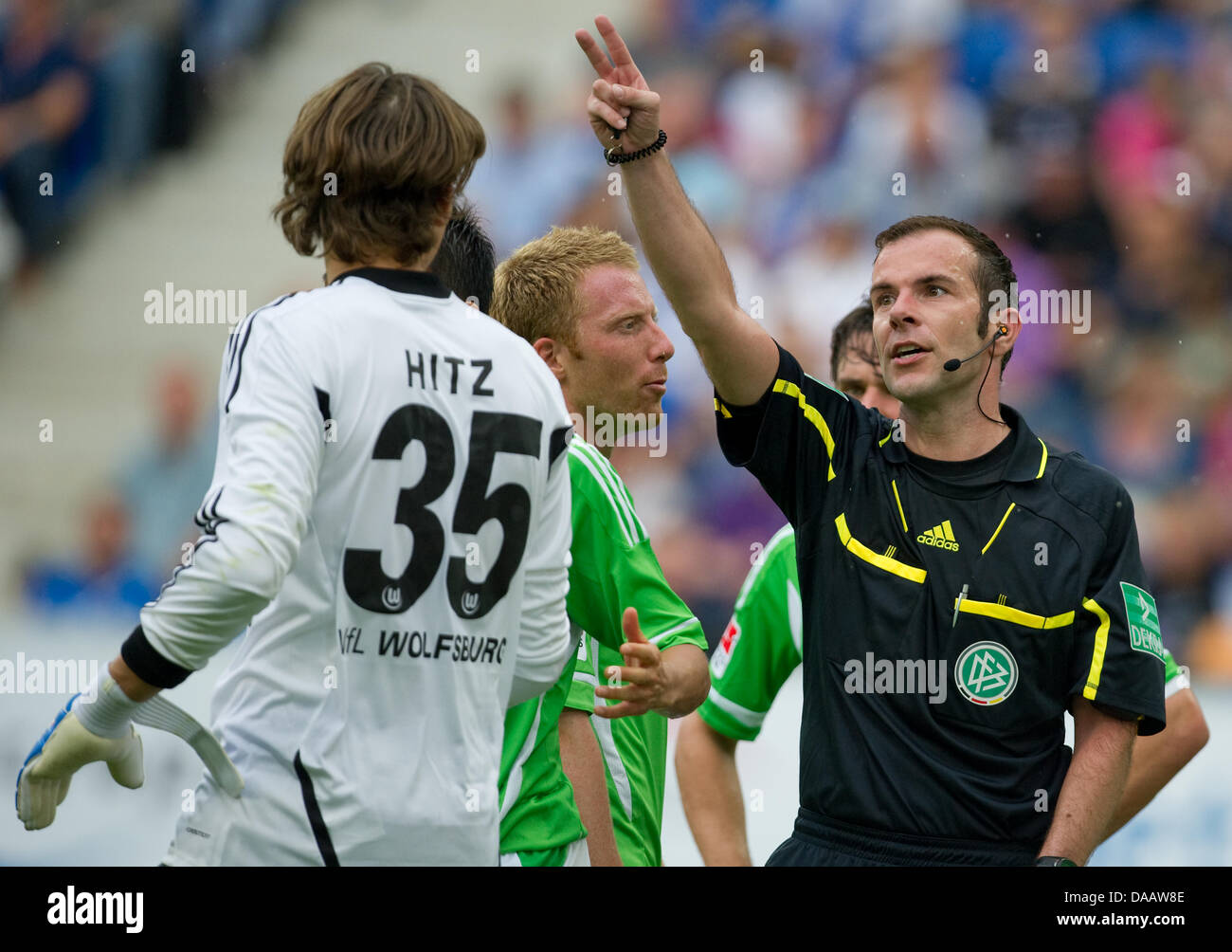 Referee Marco Fritz (R) sends Wolfsburg's goalie Marwin Hitz (L) off ...