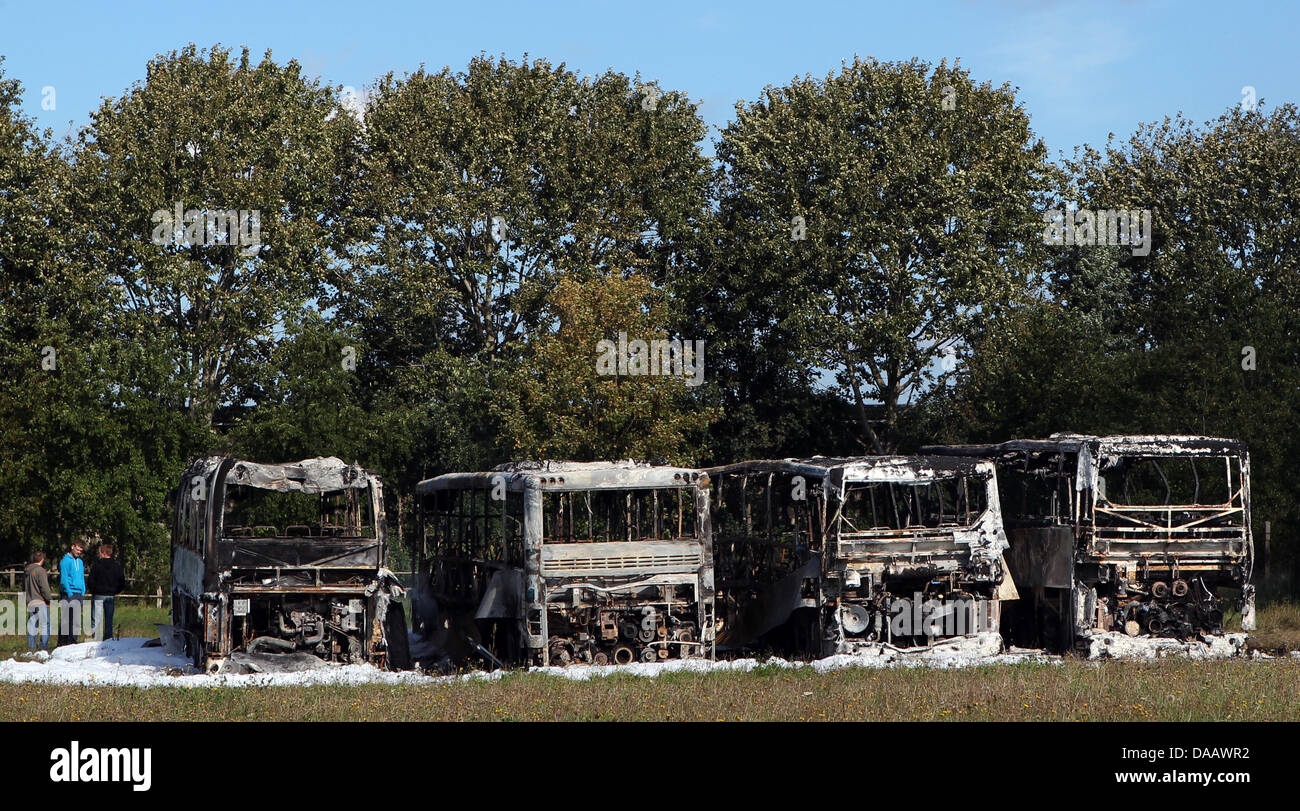 Four burnt-out busses are situated on a meadow near the federal highway ...