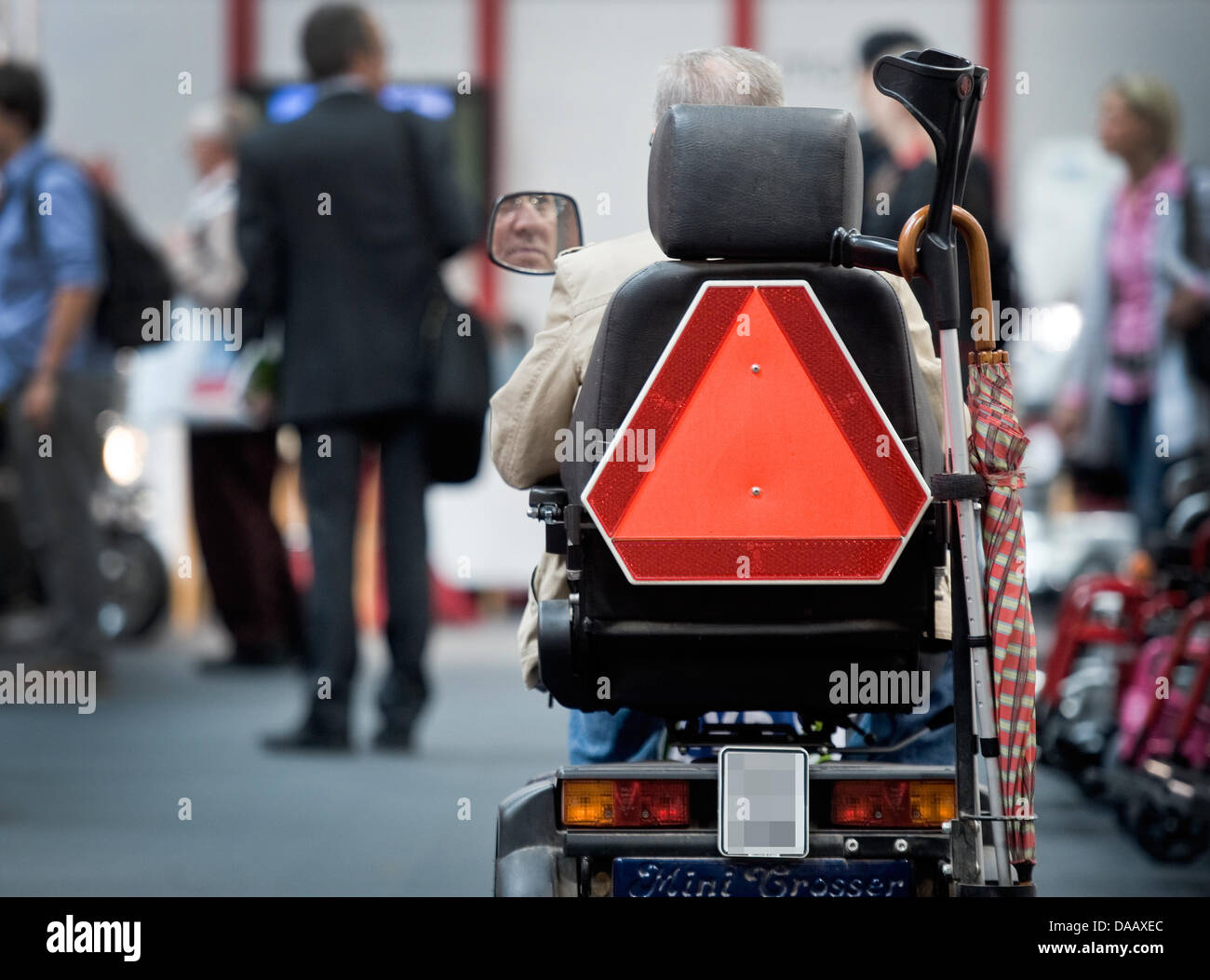 A man drives an electronic wheelchair at the rehabilitation fair ...