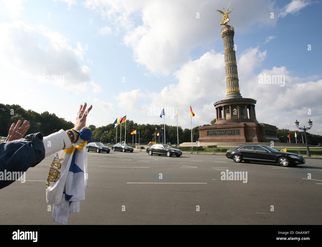 Passersby waving, while Pope Benedict XVI on his way to Bellevue Palace ...