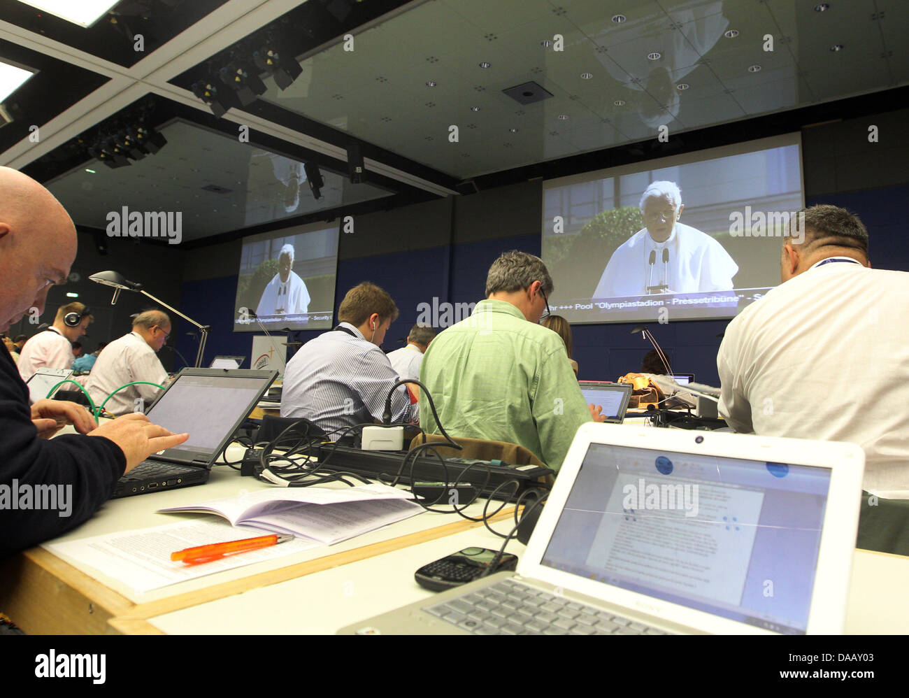 Journalists work in a pressroom during the speech of Pope Benedict XVI ...
