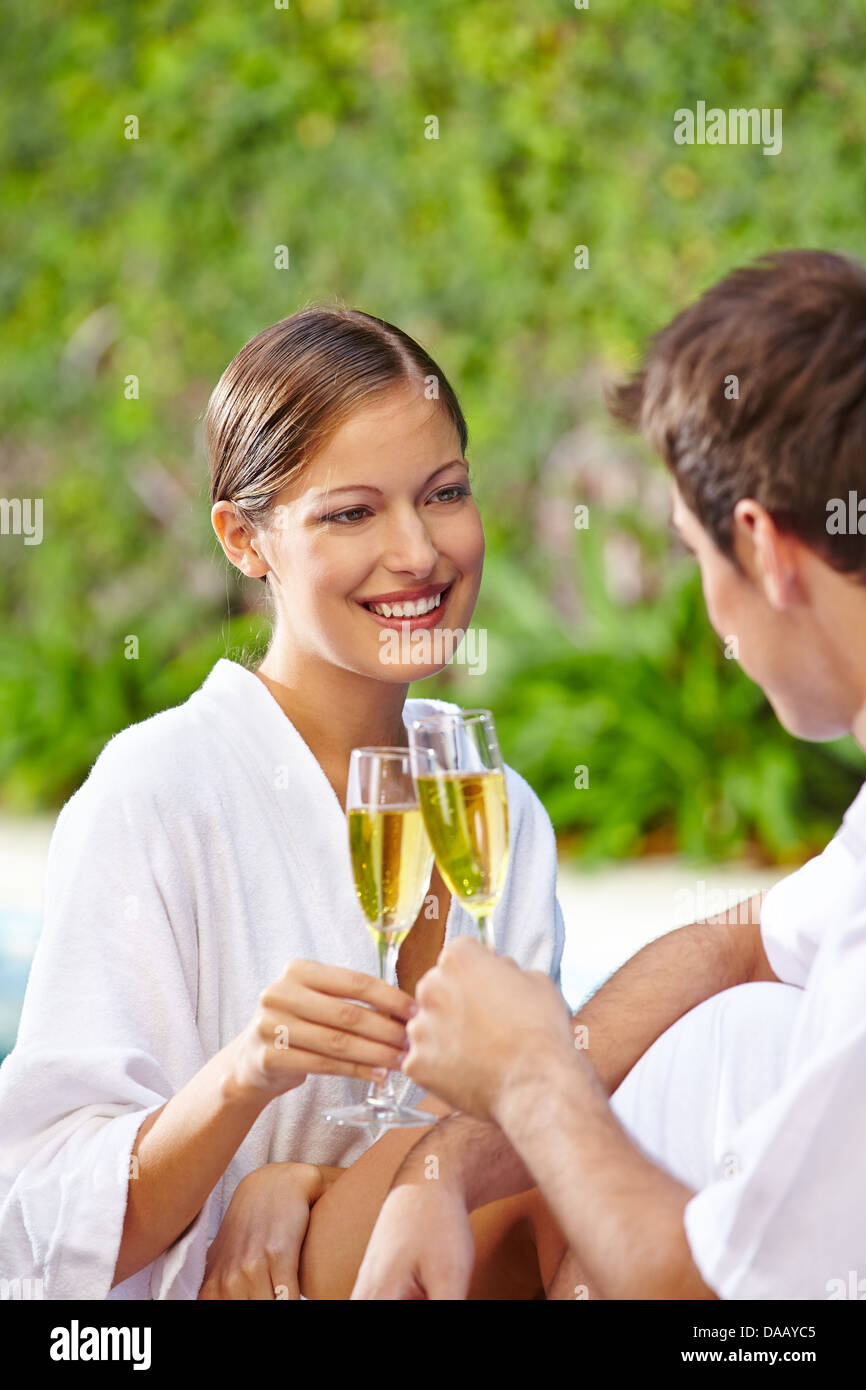 Happy couple in holiday drinking champagne at pool of hotel Stock Photo ...