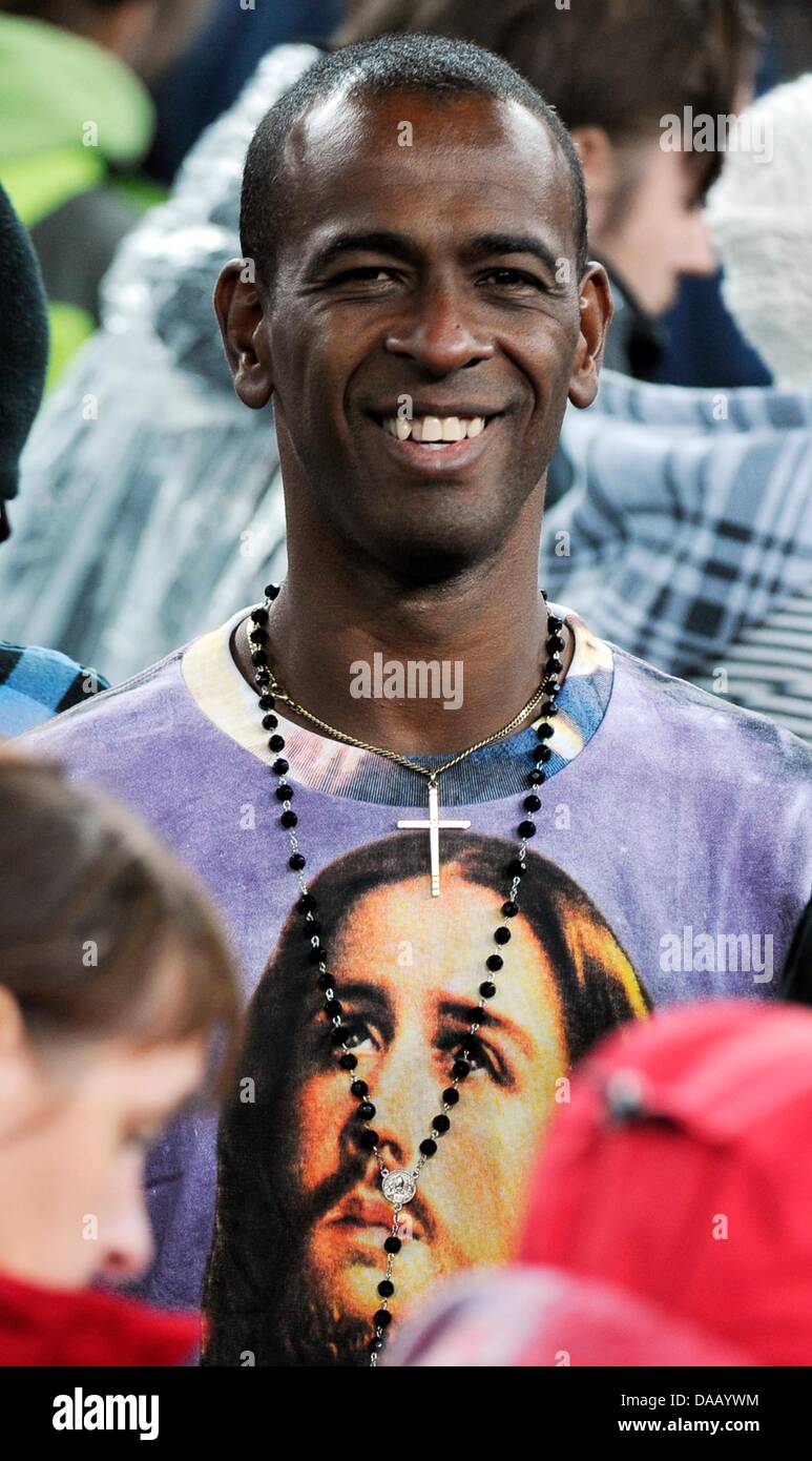 A believer smiles during the mass of Pope Benedict XVI at the Olympic ...