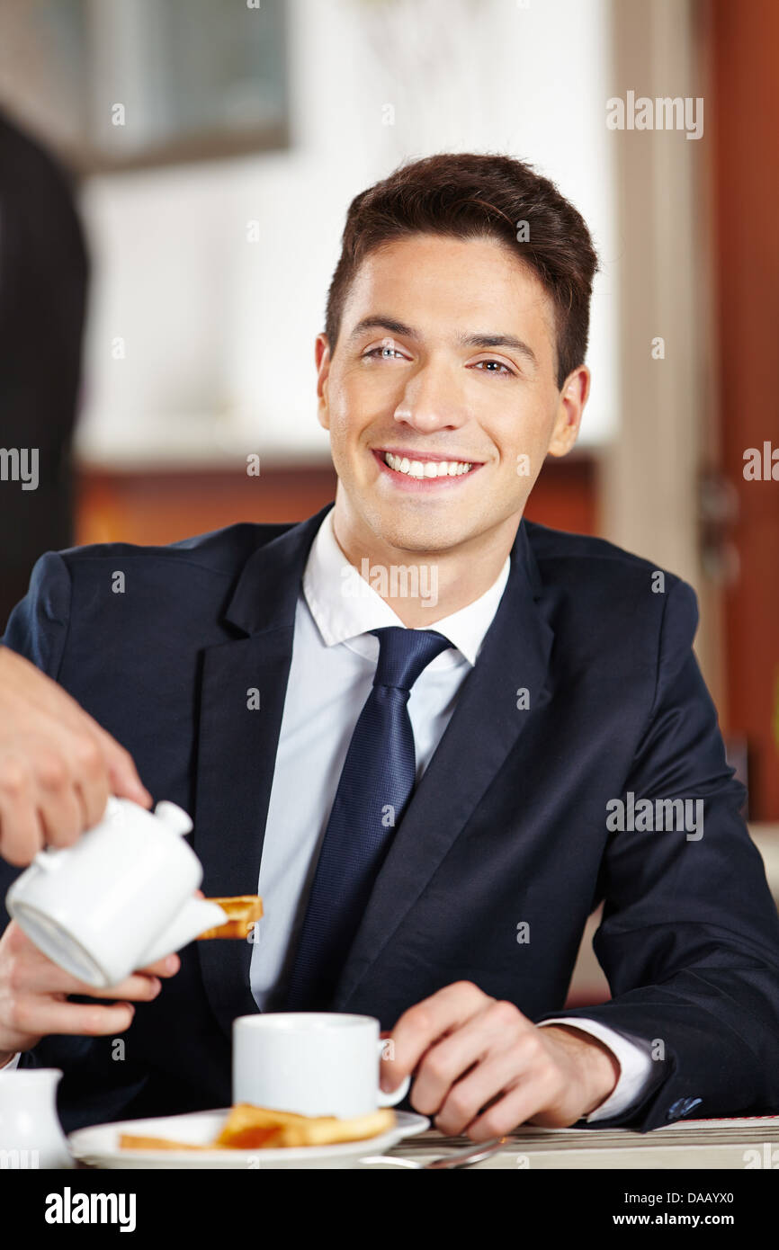 Happy businessman eating breakfast in coffee shop of a hotel Stock ...