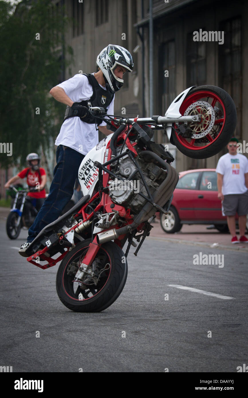Stunt motorbiker practicing his skills on empty road. Katowice, Poland ...
