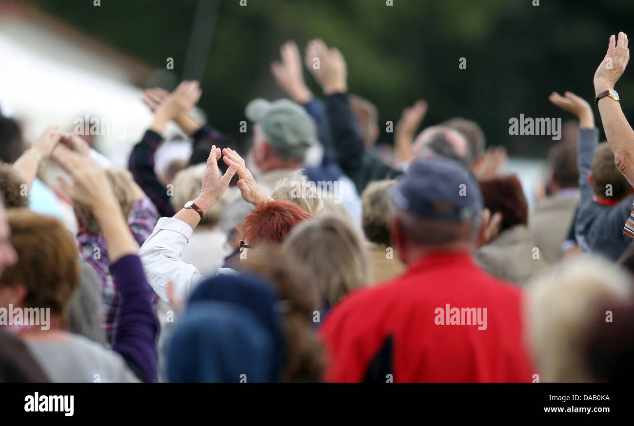 Believers clap their hands at the pilgrimage church prior a mass with ...