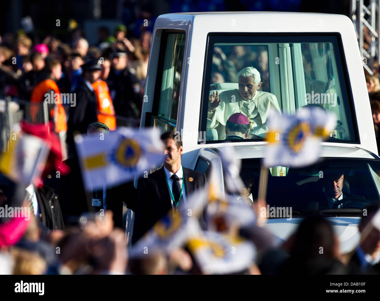 Pope Benedict XVI drives trough the faithful with his Papamobil before ...