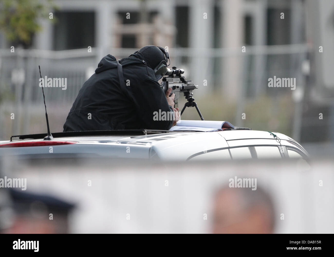A member of a special police unit with a machine gun secures the area ...