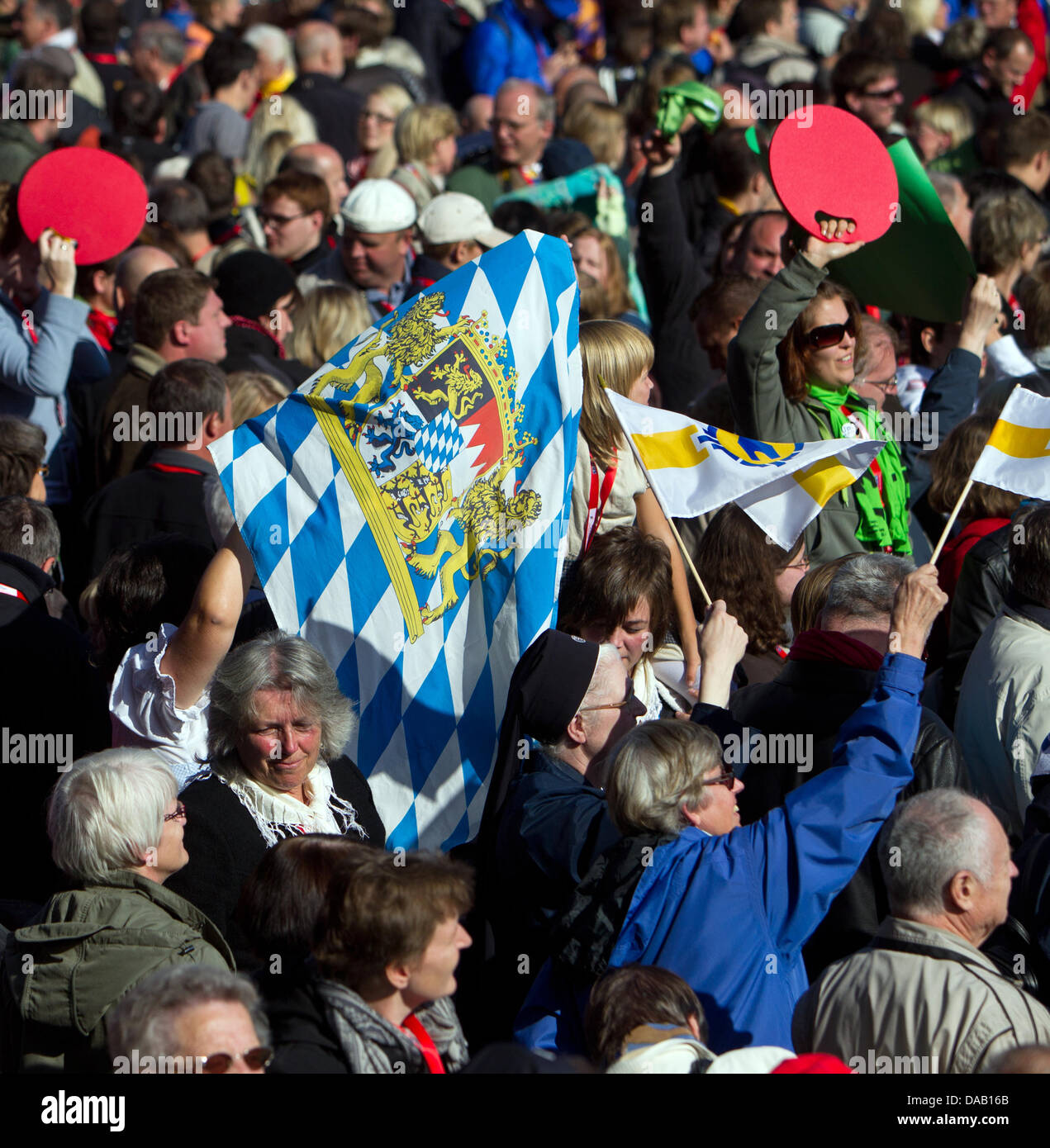 Belivers holding flags during a mass celebrated by Pope Benedict XVI in ...