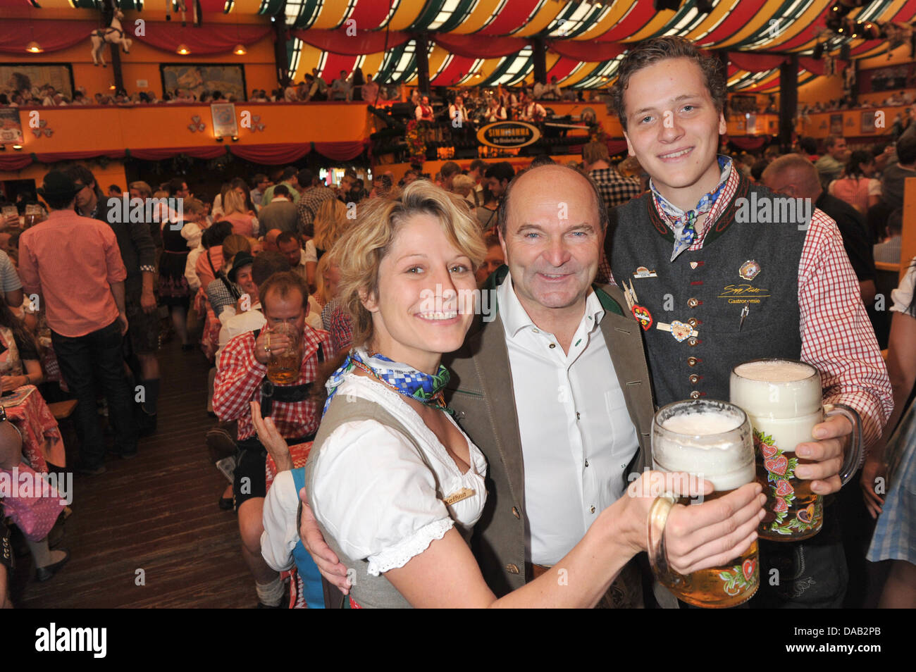 Host of the Hippodrom Sepp Kraetz (C) party tent poses with waitress ...
