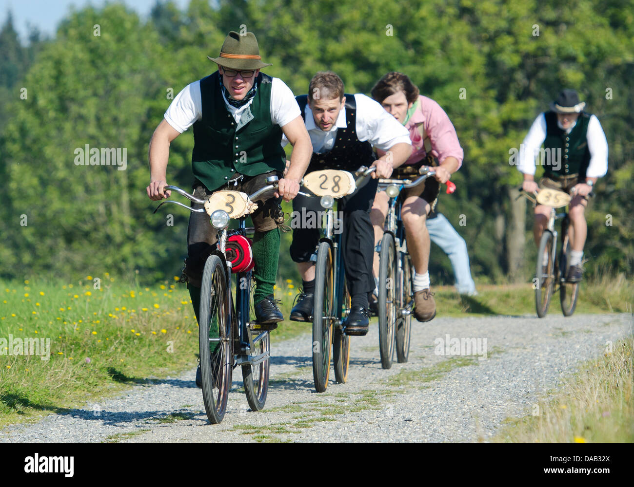 Participants of the nostalgic bike tour cycle on historic bikes in ...