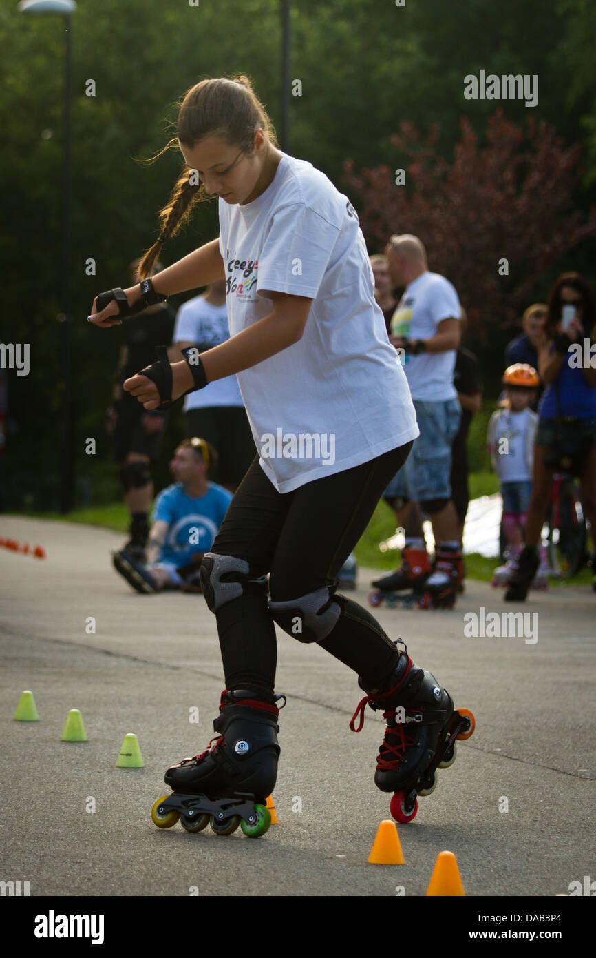 Teenage girl roller blading through slalom cones Stock Photo - Alamy