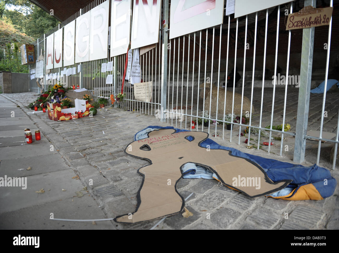 Protest posters are fixed to a fence underneath a bridge in Hamburg ...