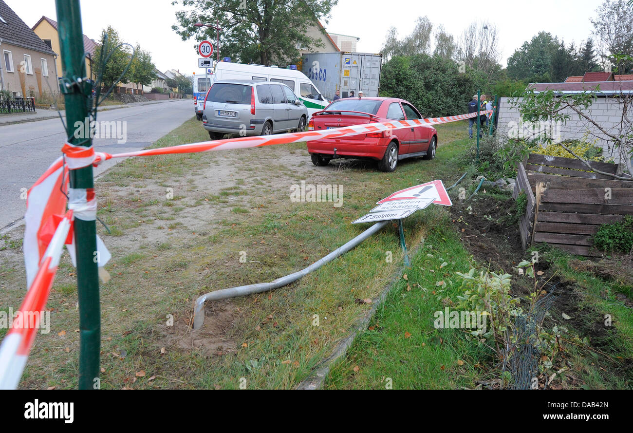 Skid marks and a knocked down traffic sign indicate the way of a truck ...