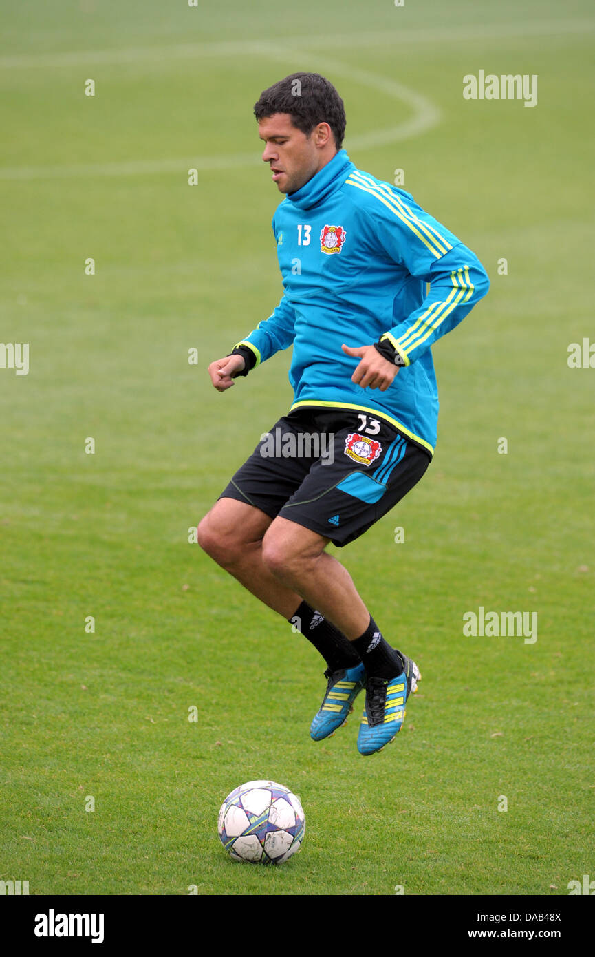 Leverkusen's Michael Ballack jumps over a balll during a training ...
