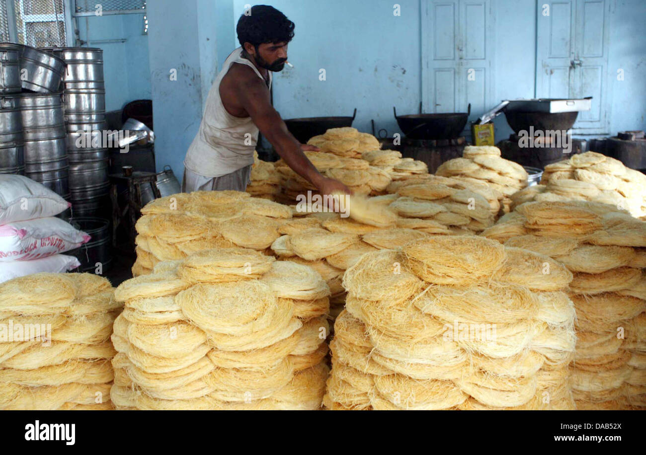Laborers busy in preparing Khajla and Pheni (traditional dish) on the ...
