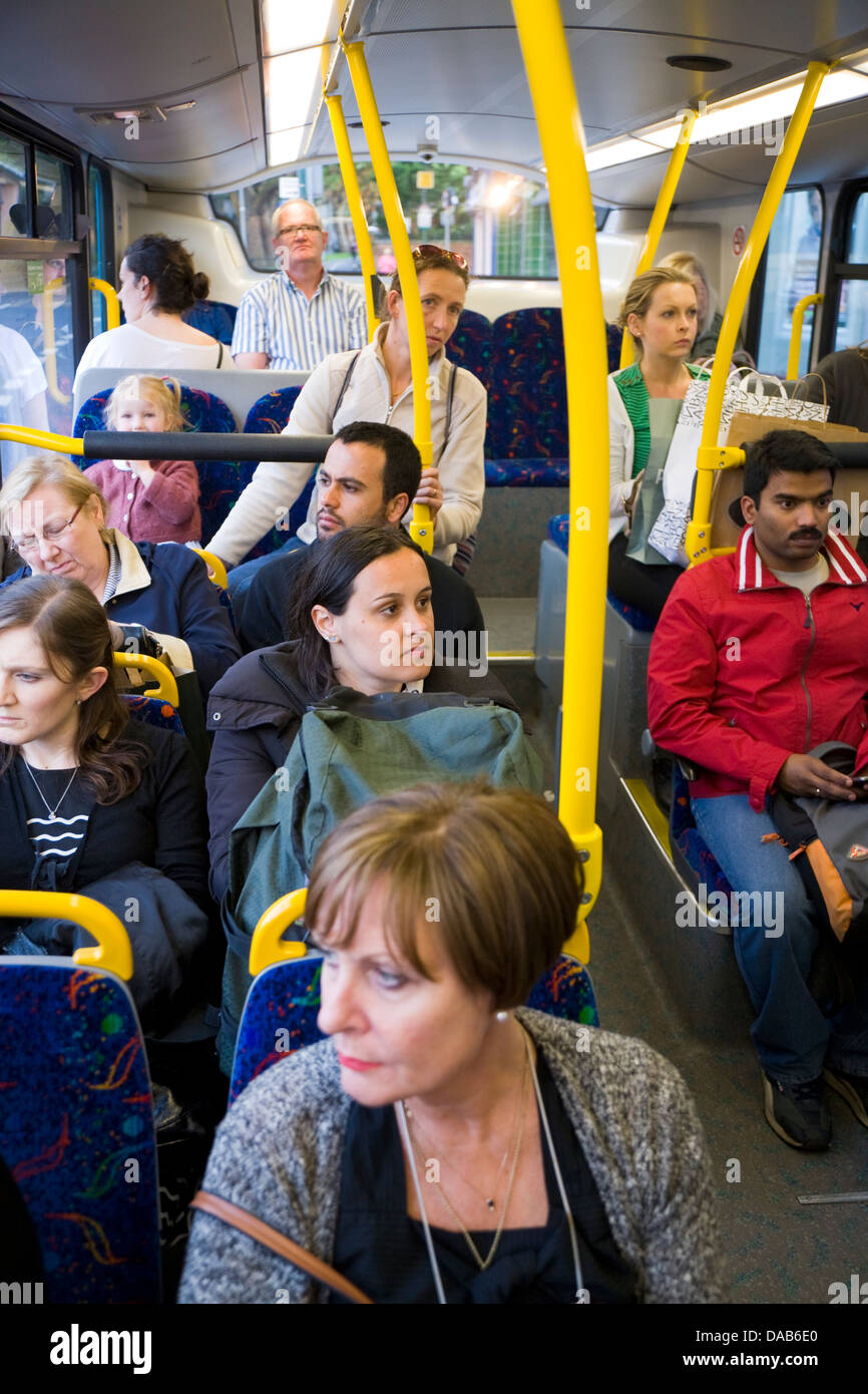 Bus passengers during a bus journey, on the lower deck of a double ...