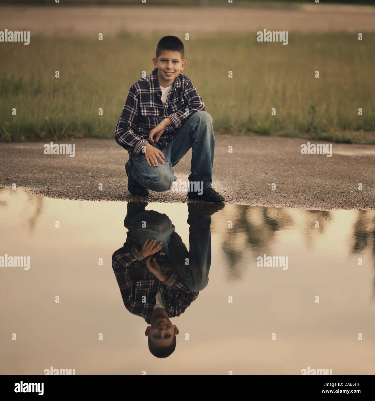 little happy boy standing in puddle Stock Photo - Alamy