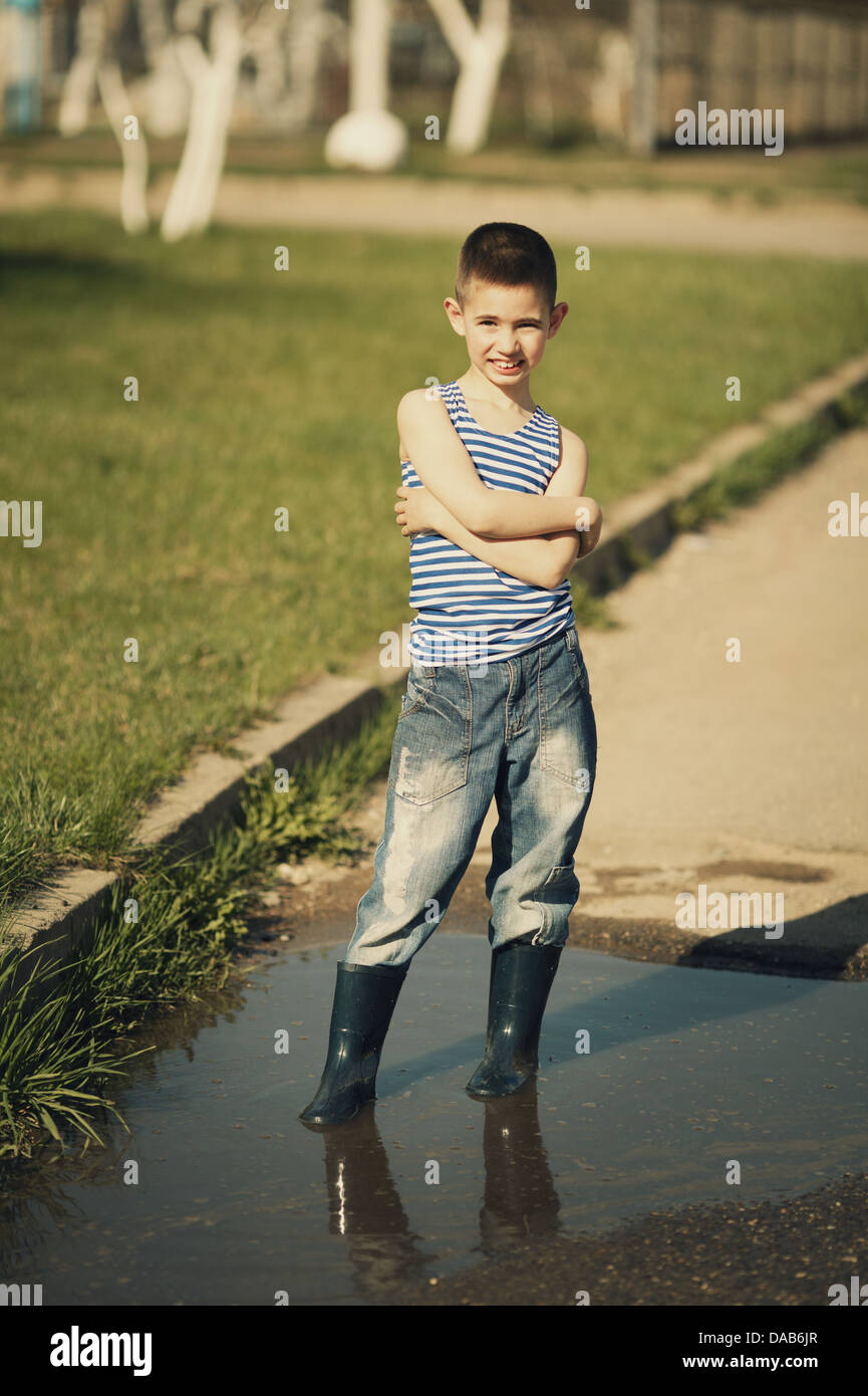 little happy boy standing in puddle Stock Photo - Alamy