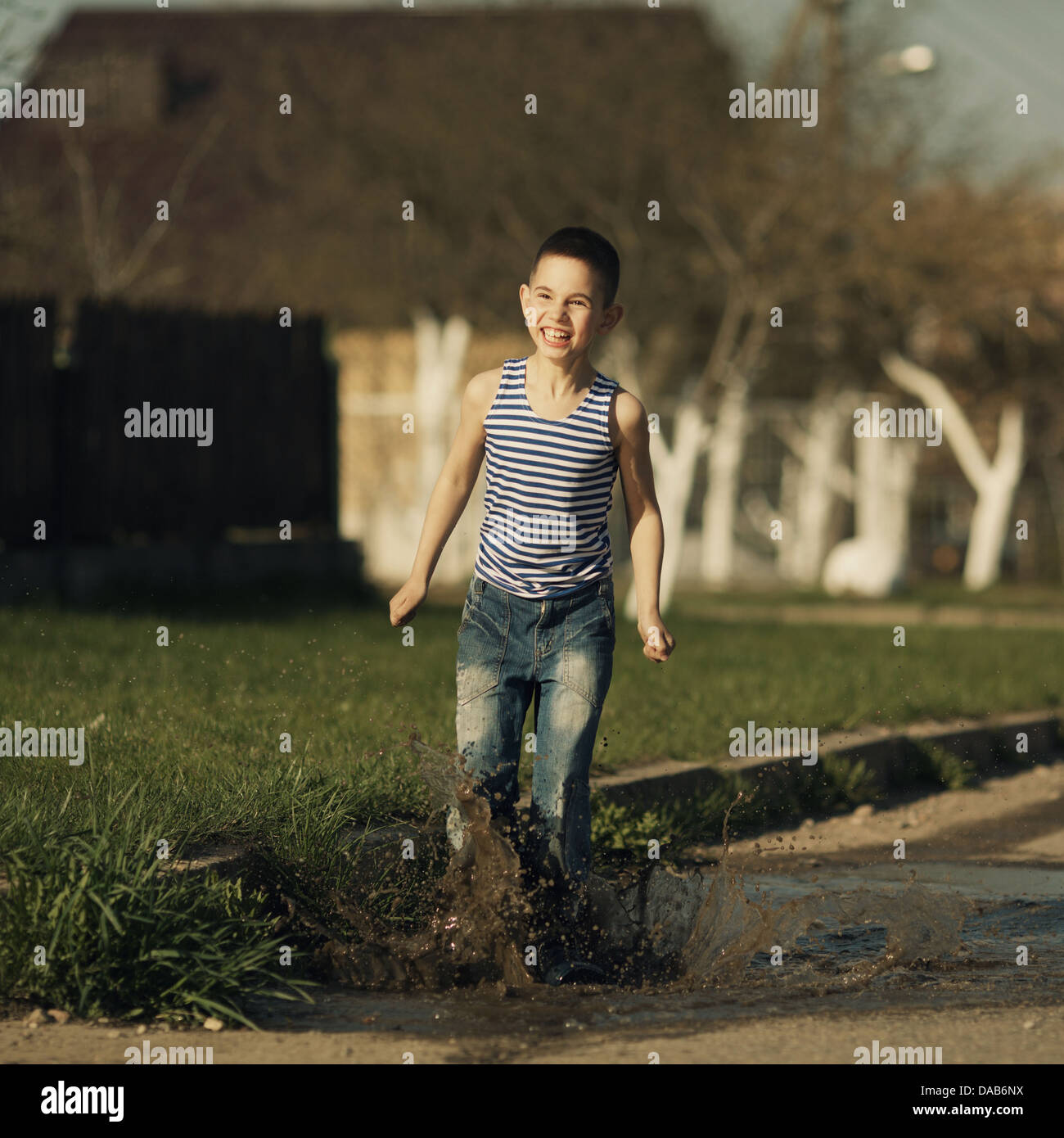 little happy boy standing in puddle Stock Photo - Alamy