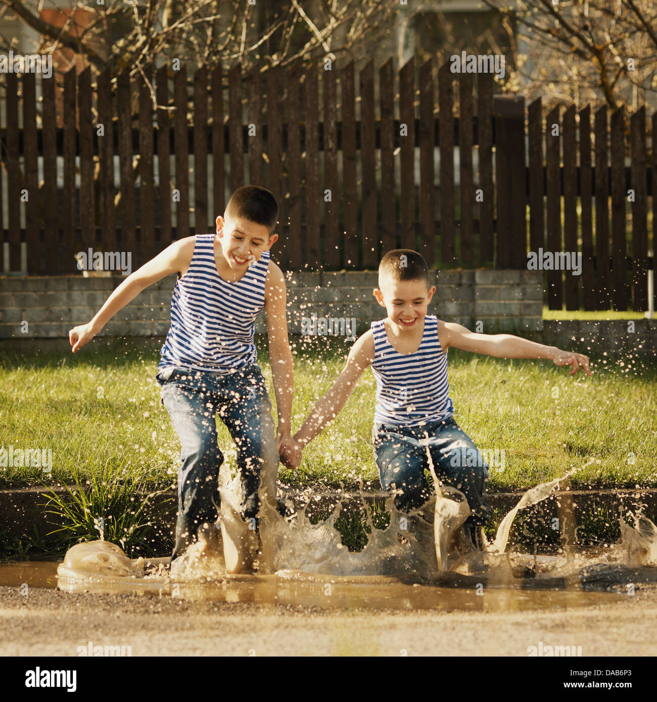 two boys in puddle Stock Photo - Alamy