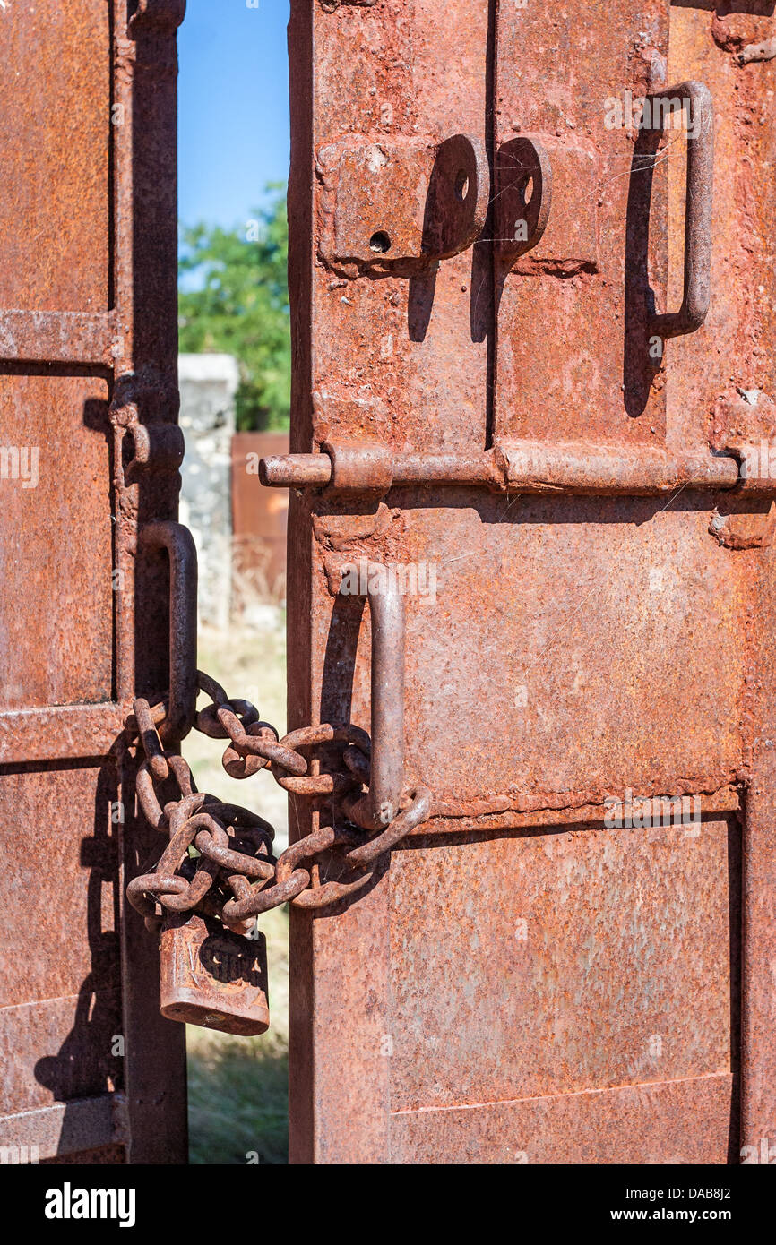 Metal gate closed with chain and padlock Stock Photo - Alamy