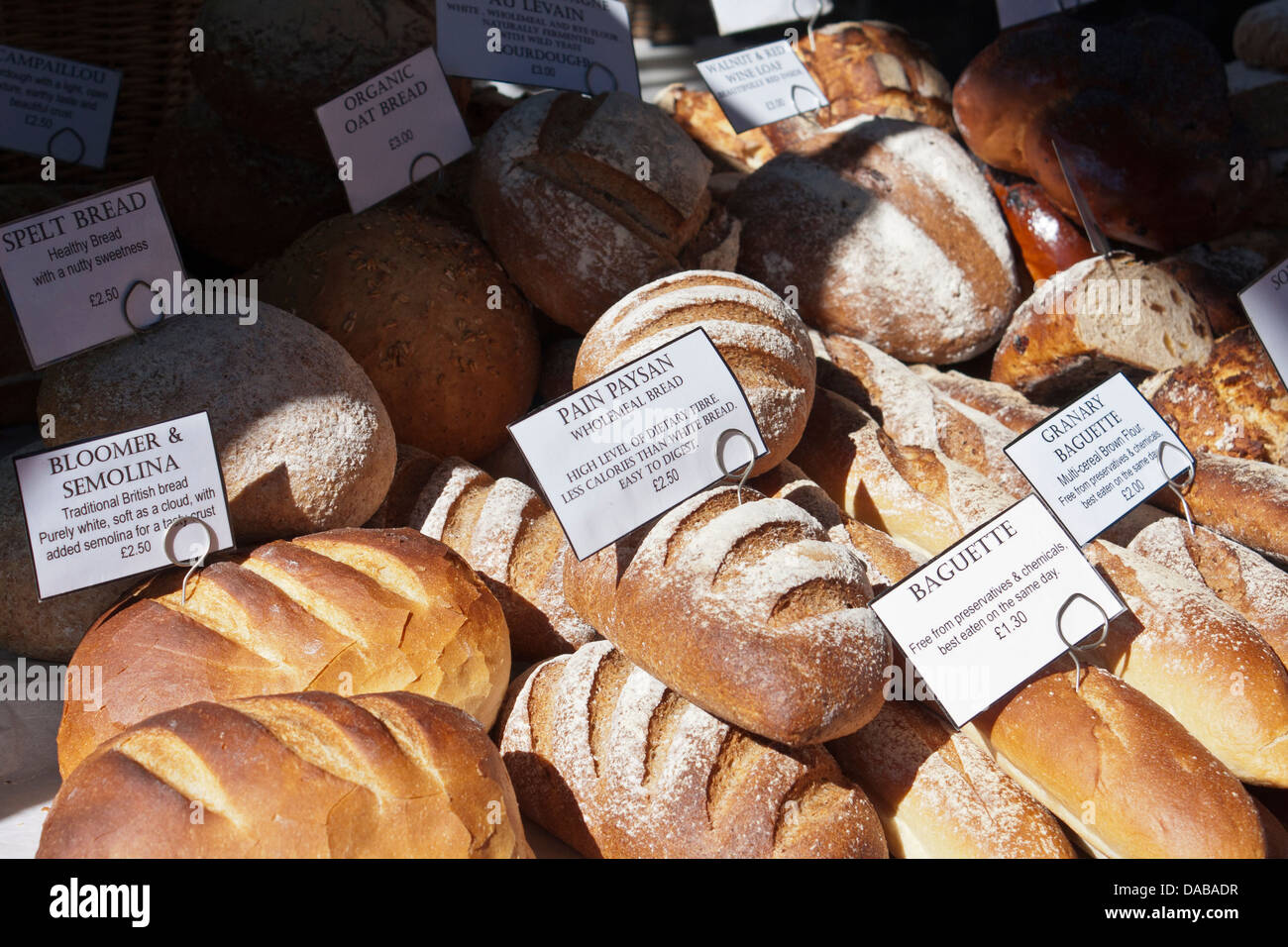 Variety of bread loaves on display at a market stall baked by an ...